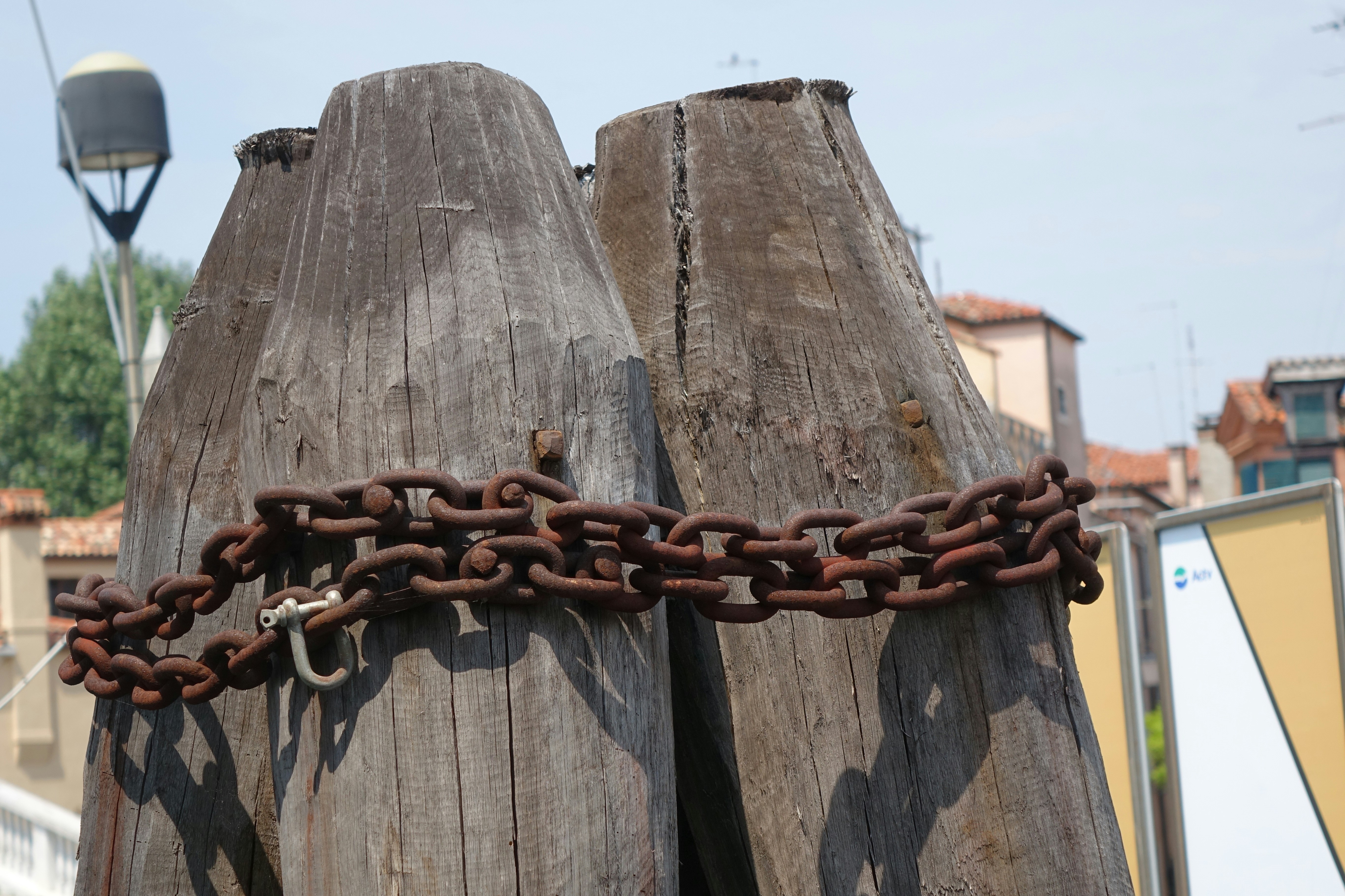 Rust and Timber: A Close-Up on Weathered Posts and a Chain