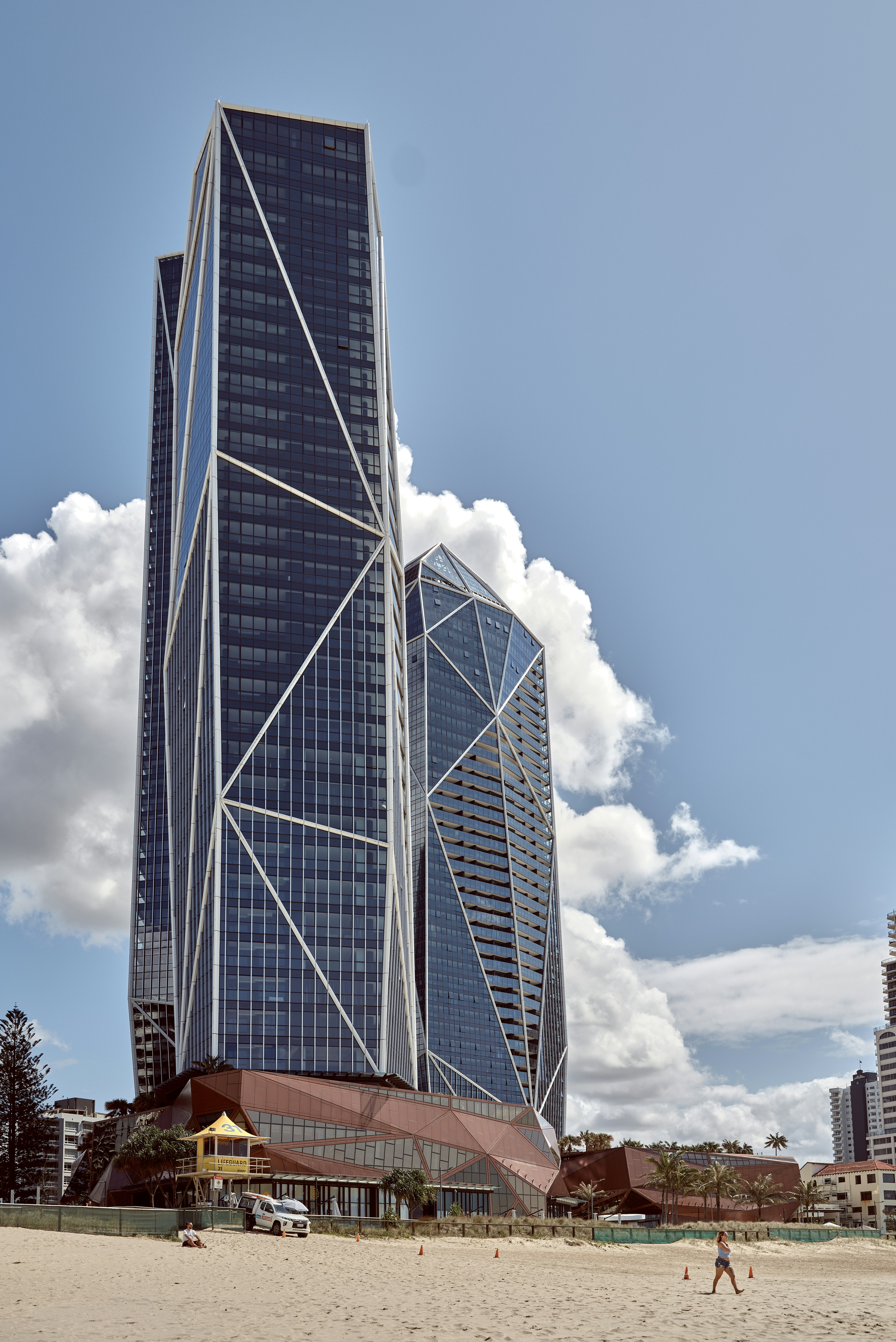 Skyward Giants: Two Faceted Towers RISE Over Coastal Sands