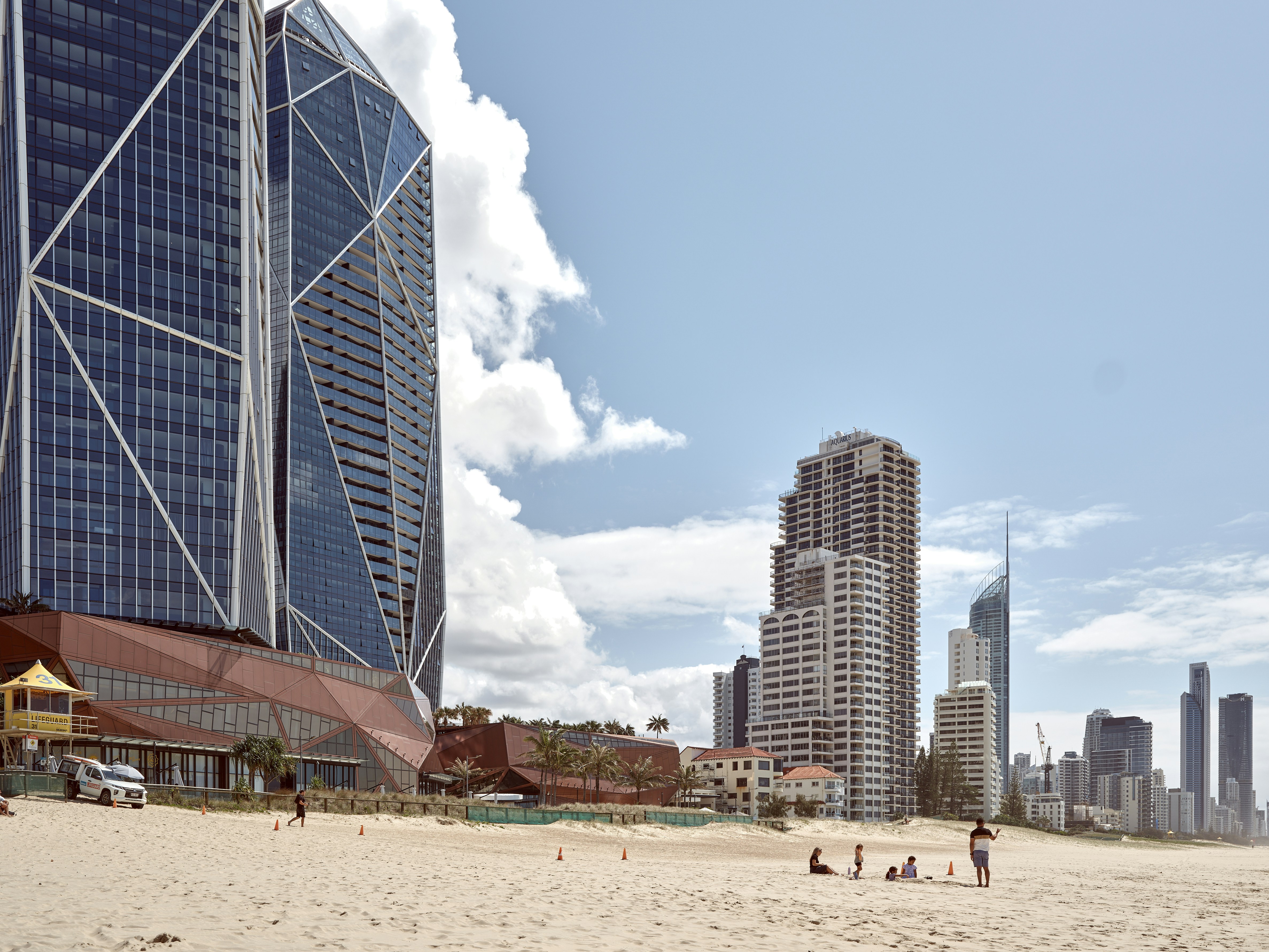 Glass-Grid Skyline Framed by the Beach