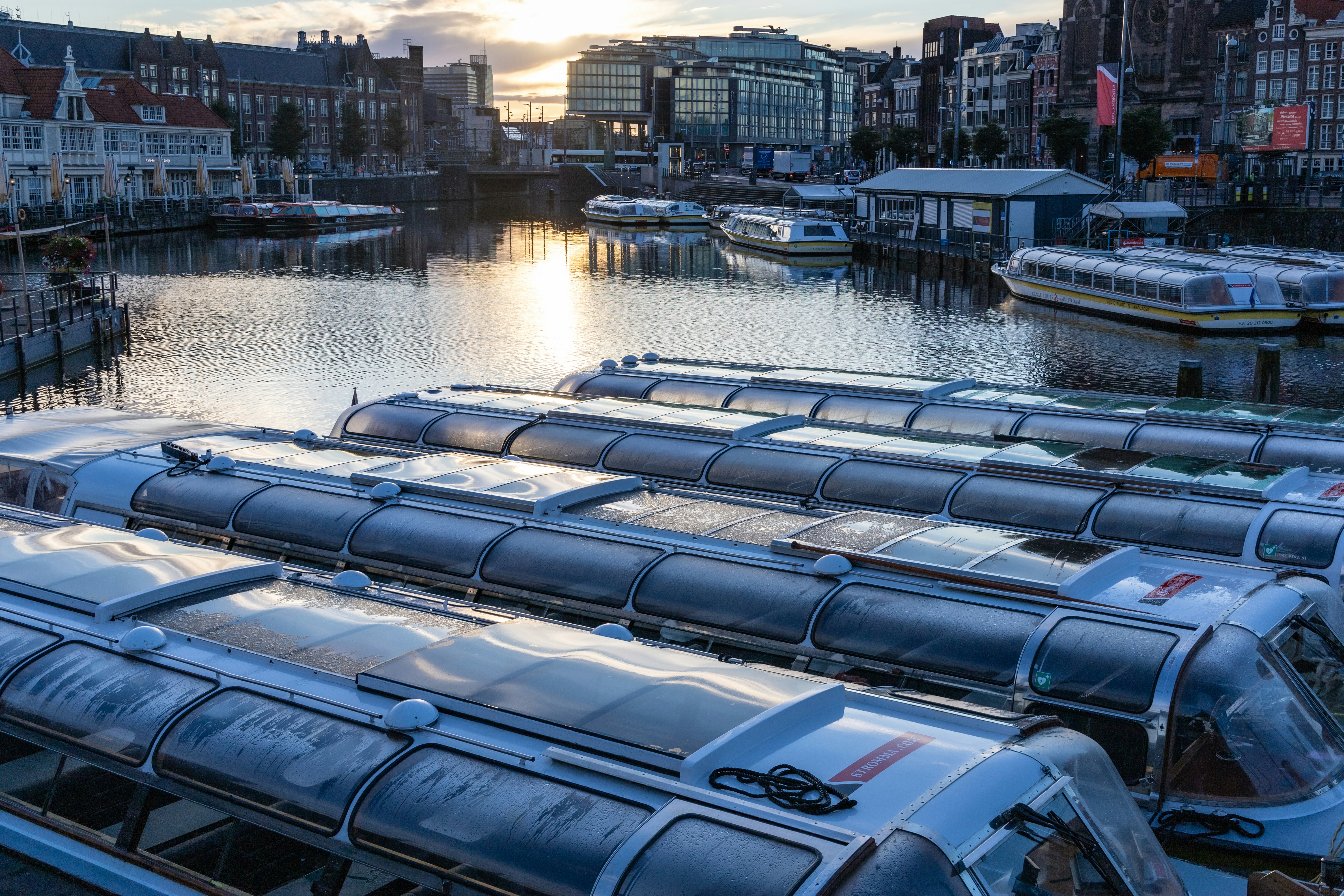 Glass rooftops of a canal harbor at sunset