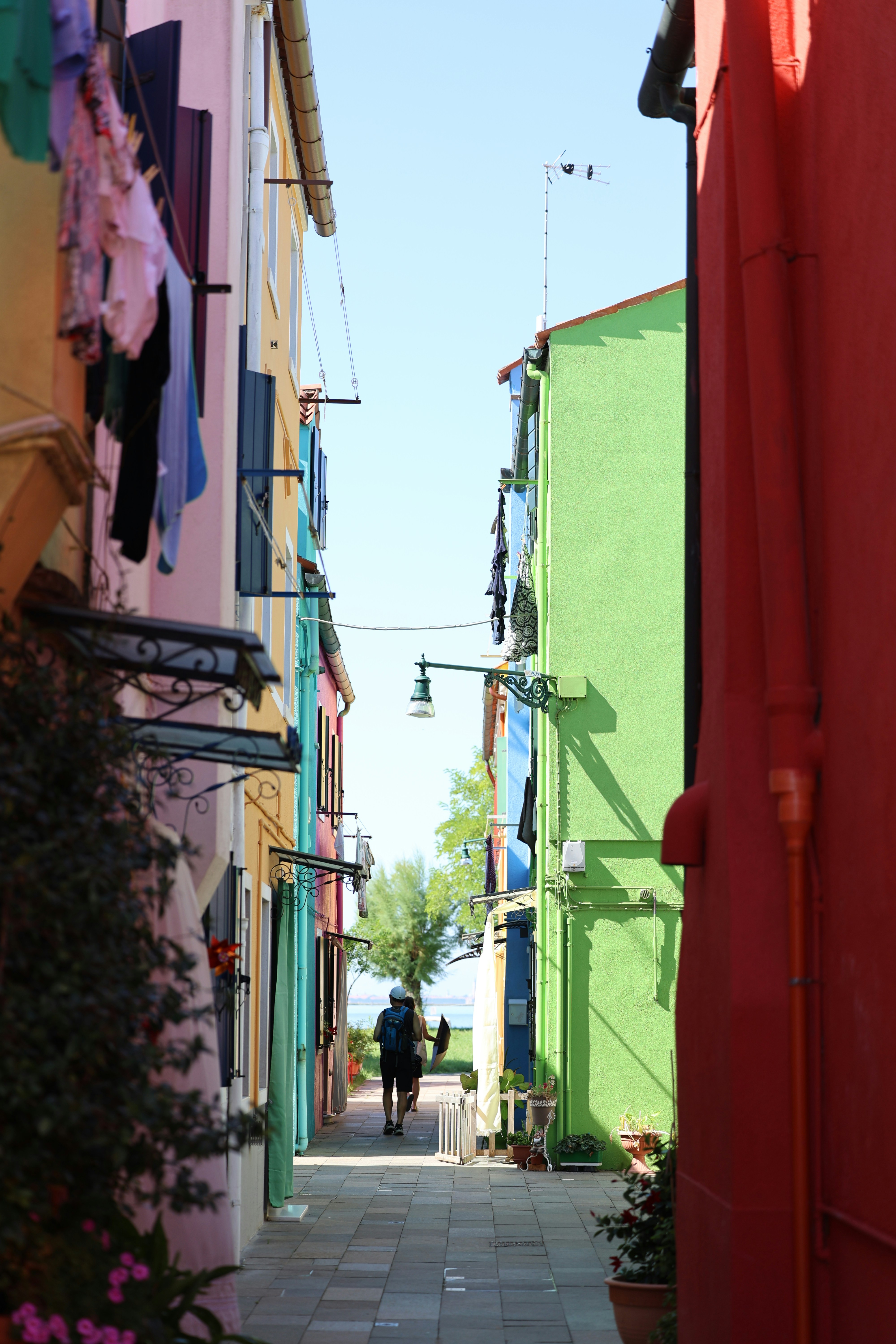 Pastel Passage: A Narrow Alley Toward the Sea