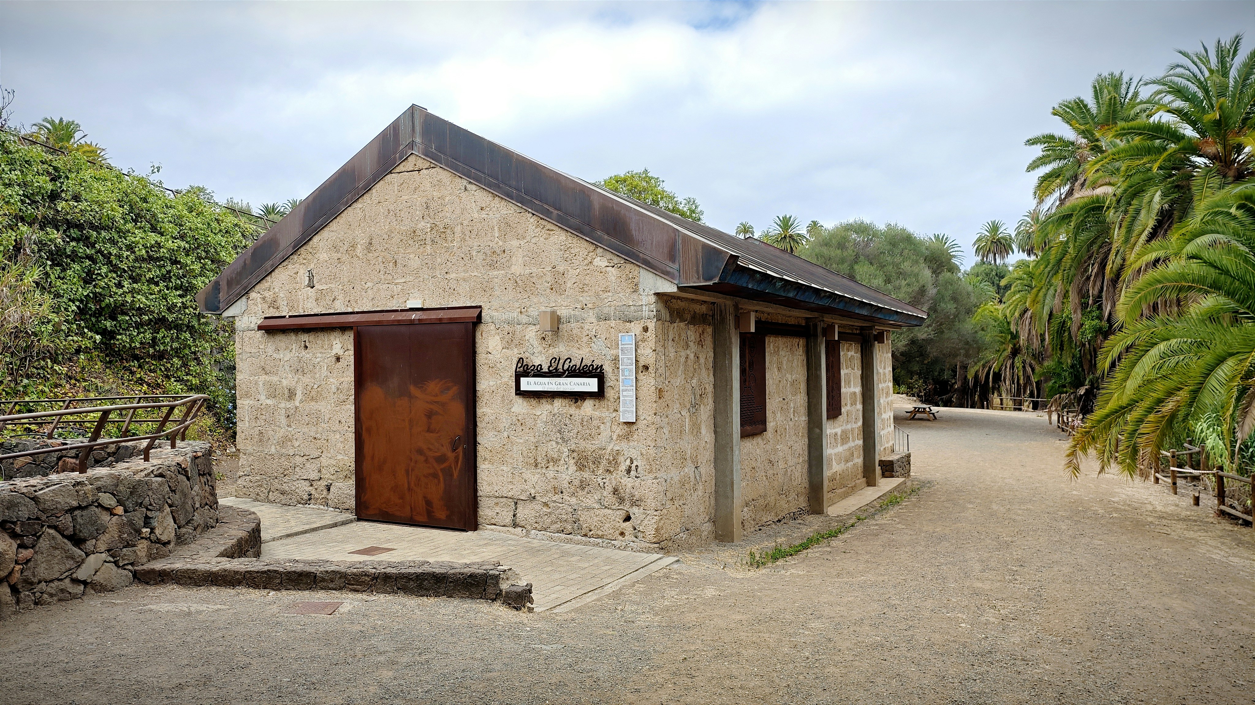 A small stone building with a door and steps leading to it photo – Free ...