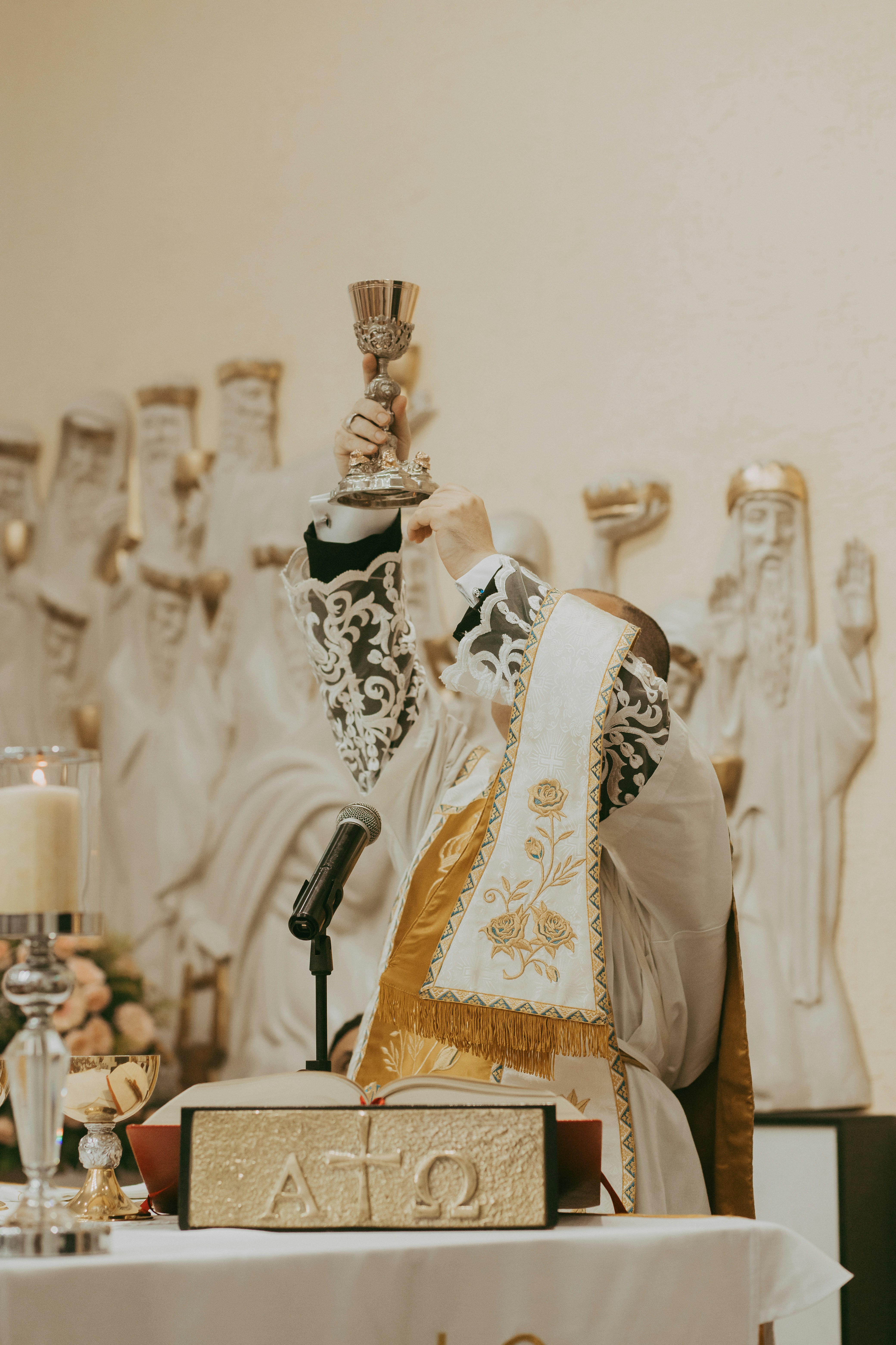 A priest is holding a cross above his head photo – Free Rio de janeiro ...