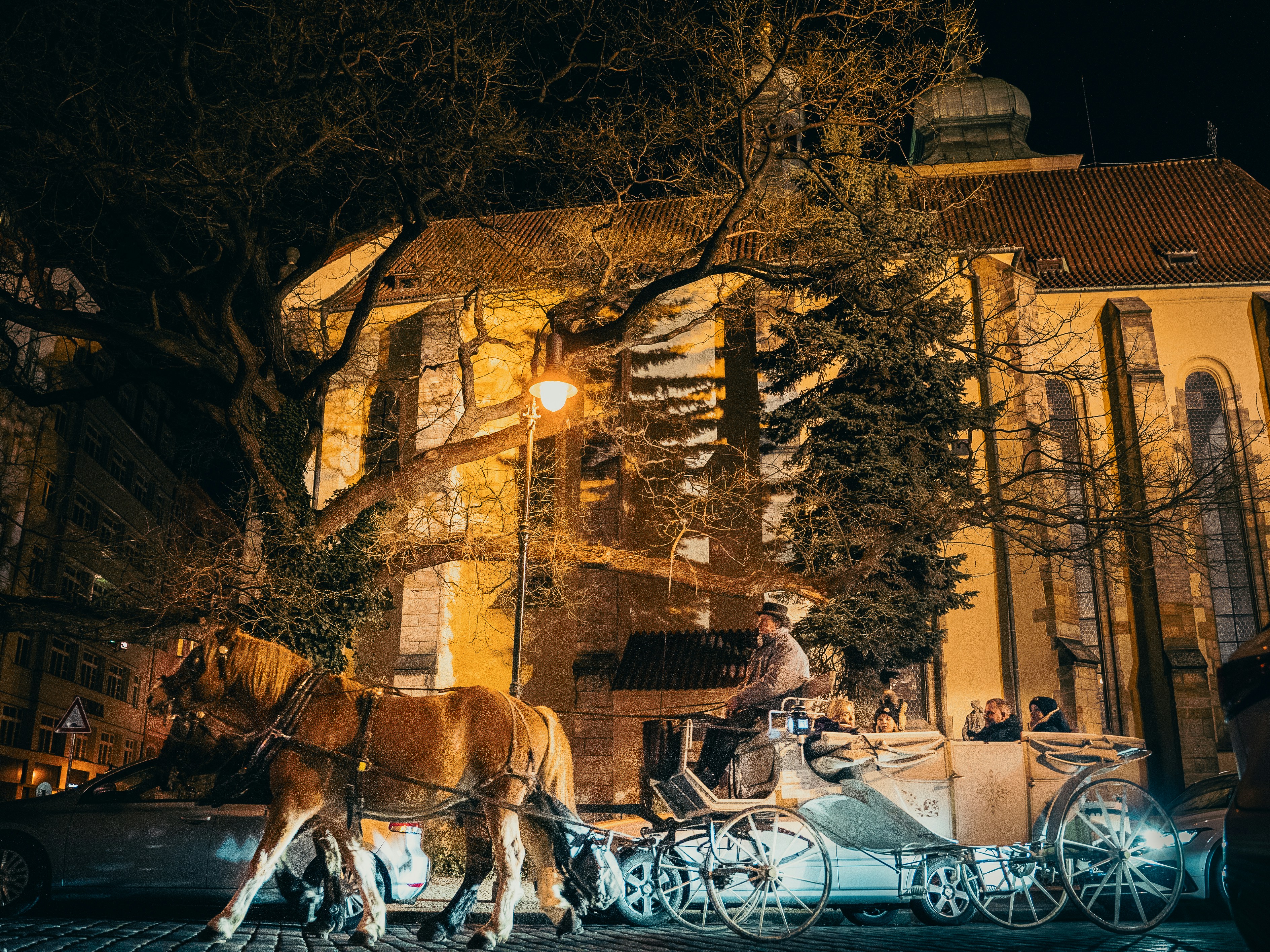 Amber Streetlight Tango: A Horse-Drawn Carriage in a Night Square