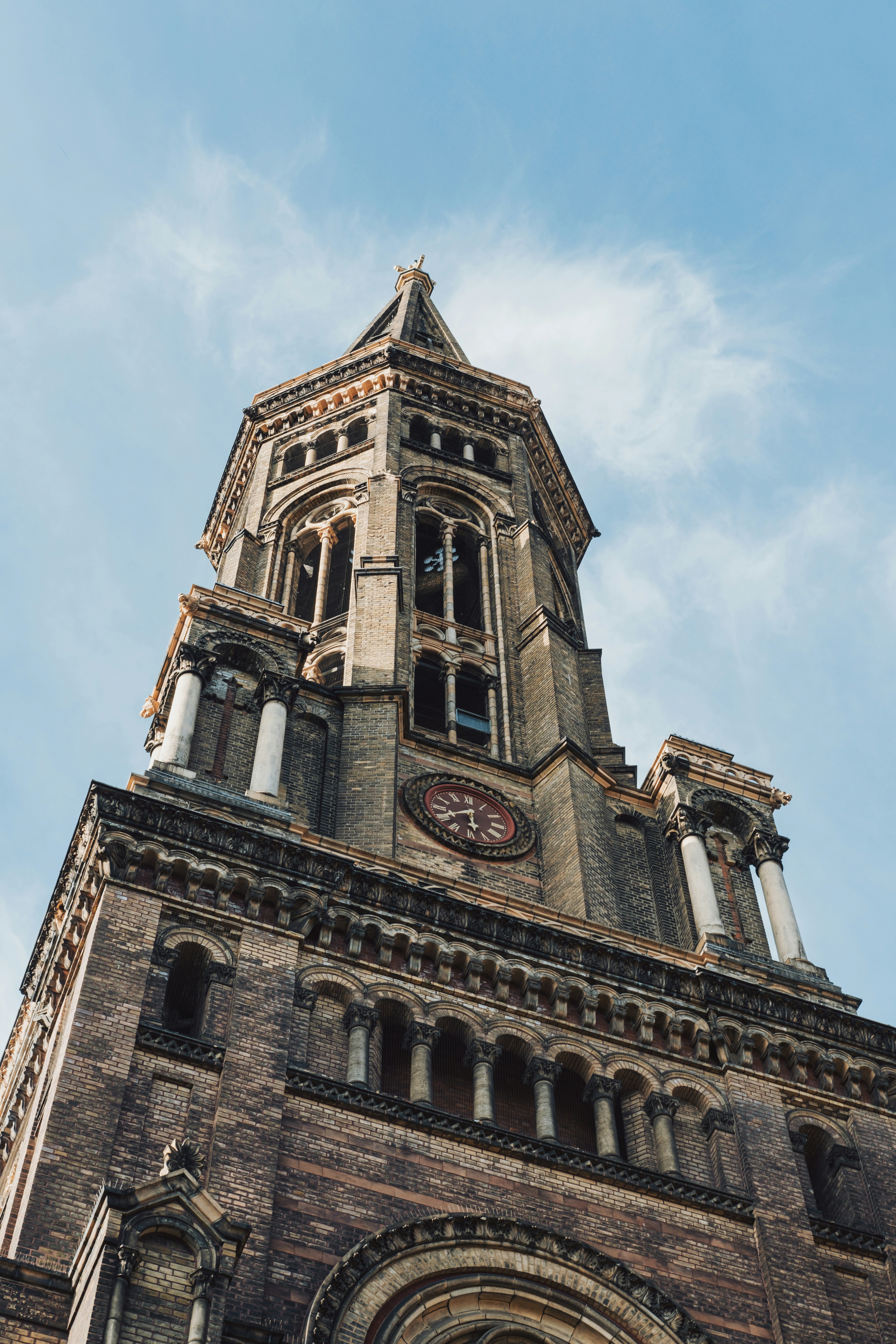 A very tall tower with a clock on it's side photo – Free Berlin Image ...