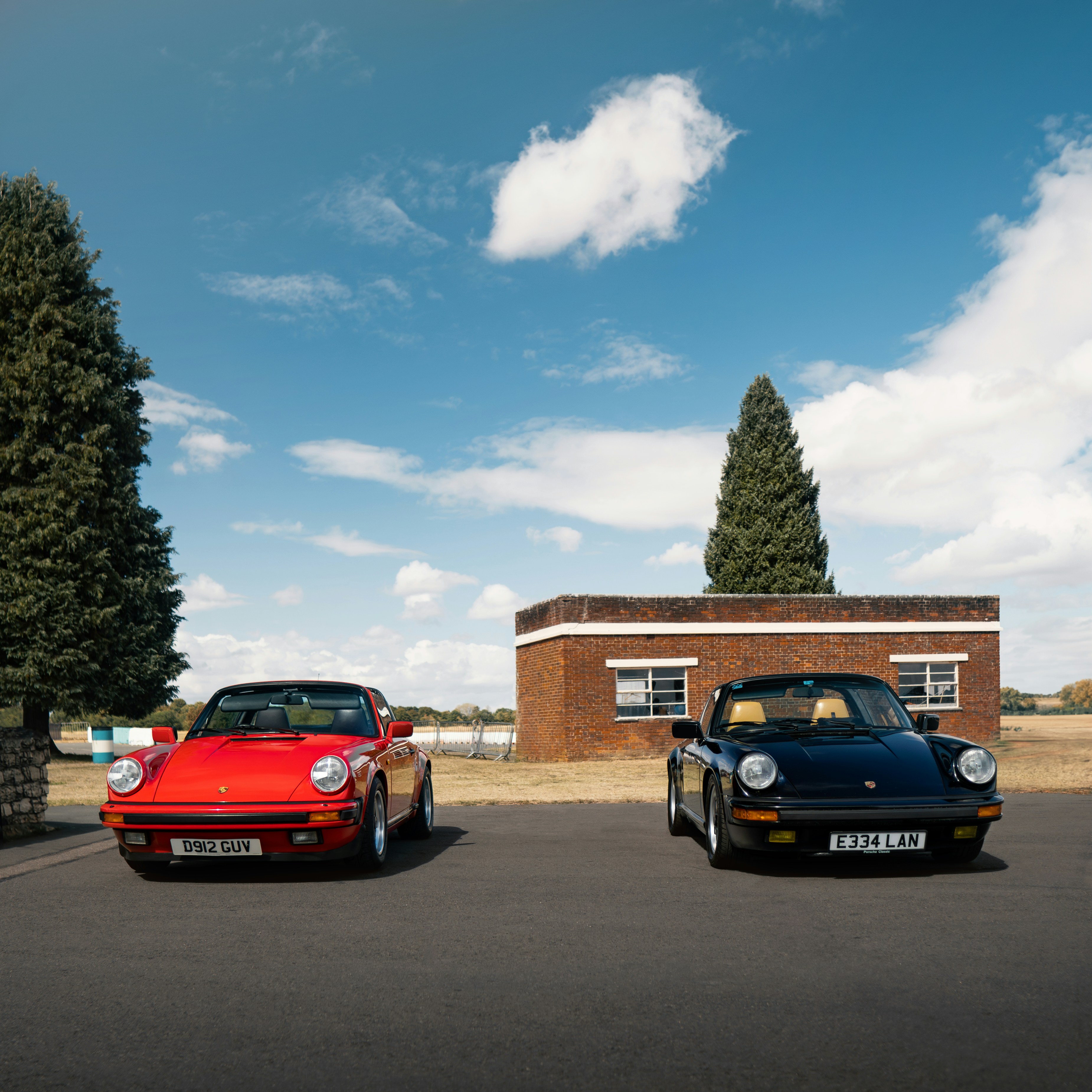 A couple of cars parked next to each other in a parking lot photo ...