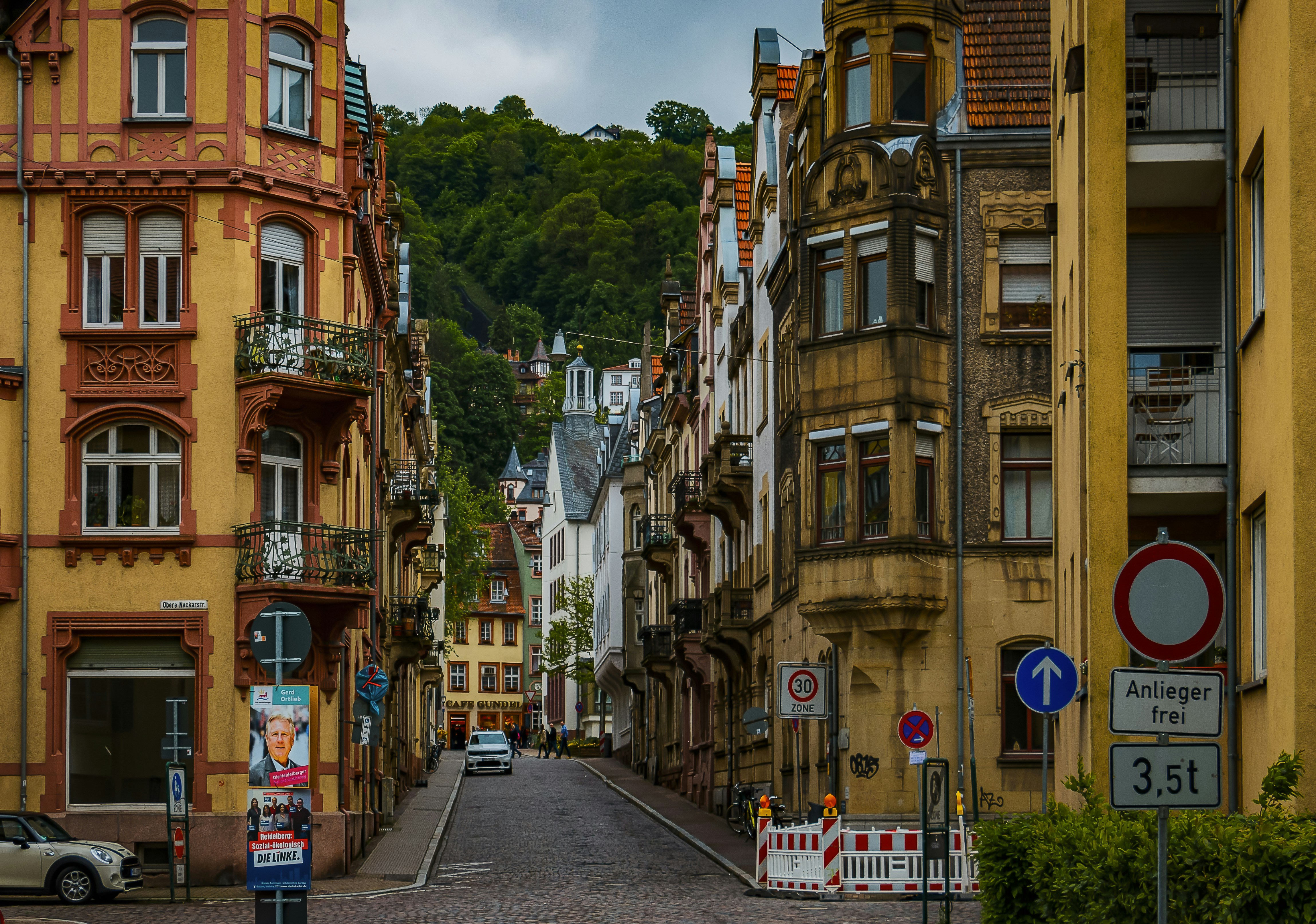 A city street lined with tall yellow buildings photo – Free Heidelberg ...