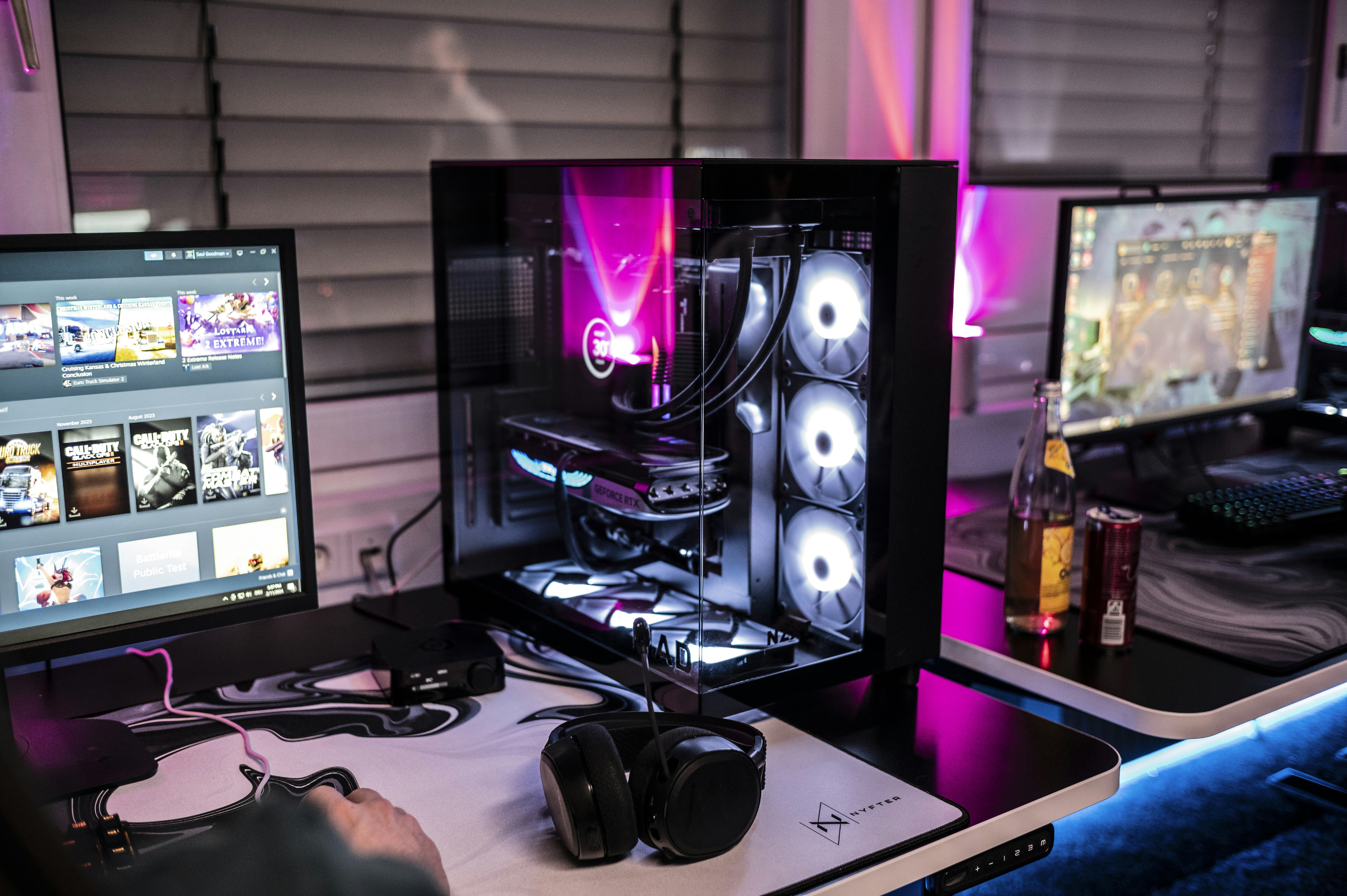 A man sitting at a desk with three computer monitors photo – Free ...