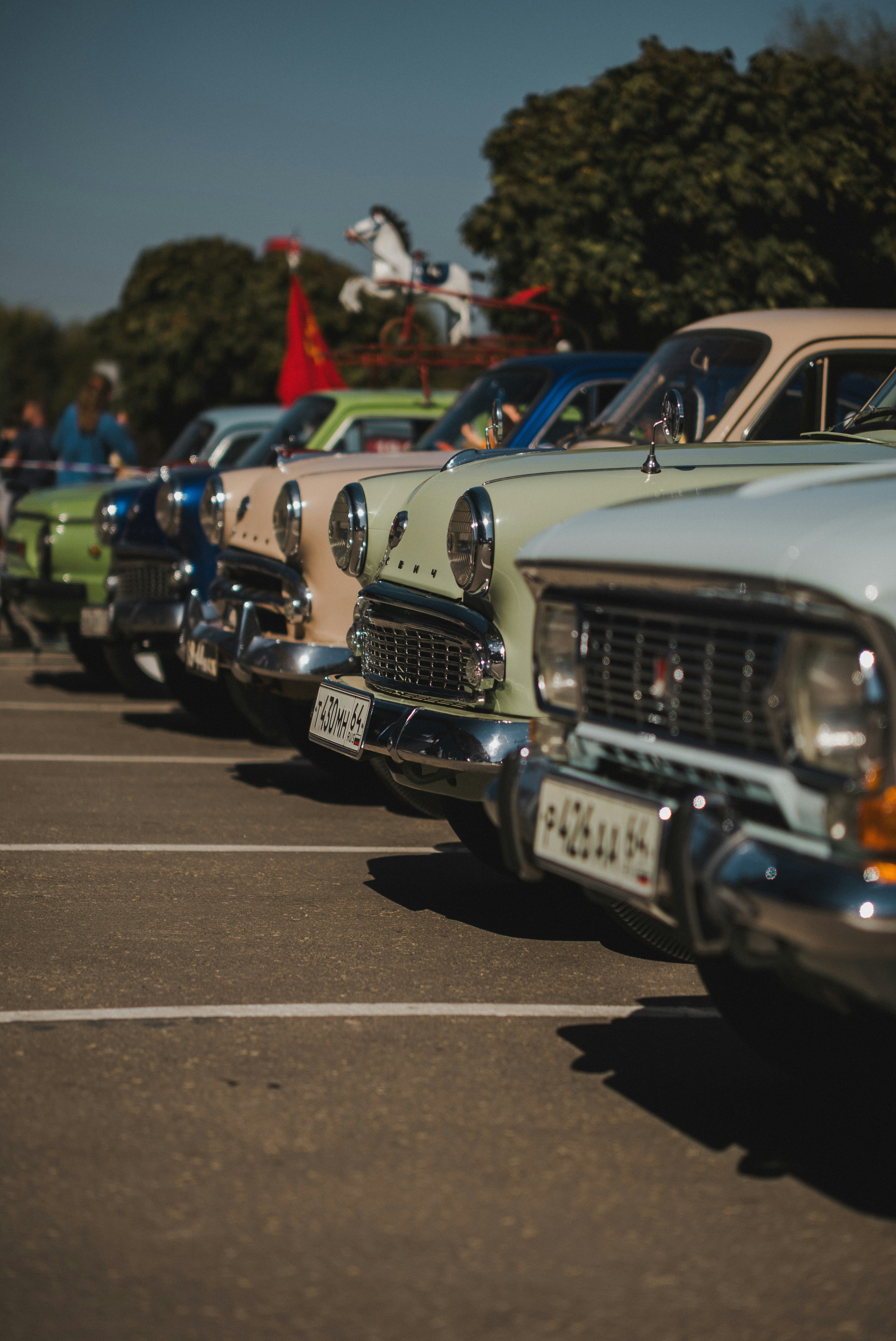 Pastel Chrome Parade: Vintage Cars Standing in Line