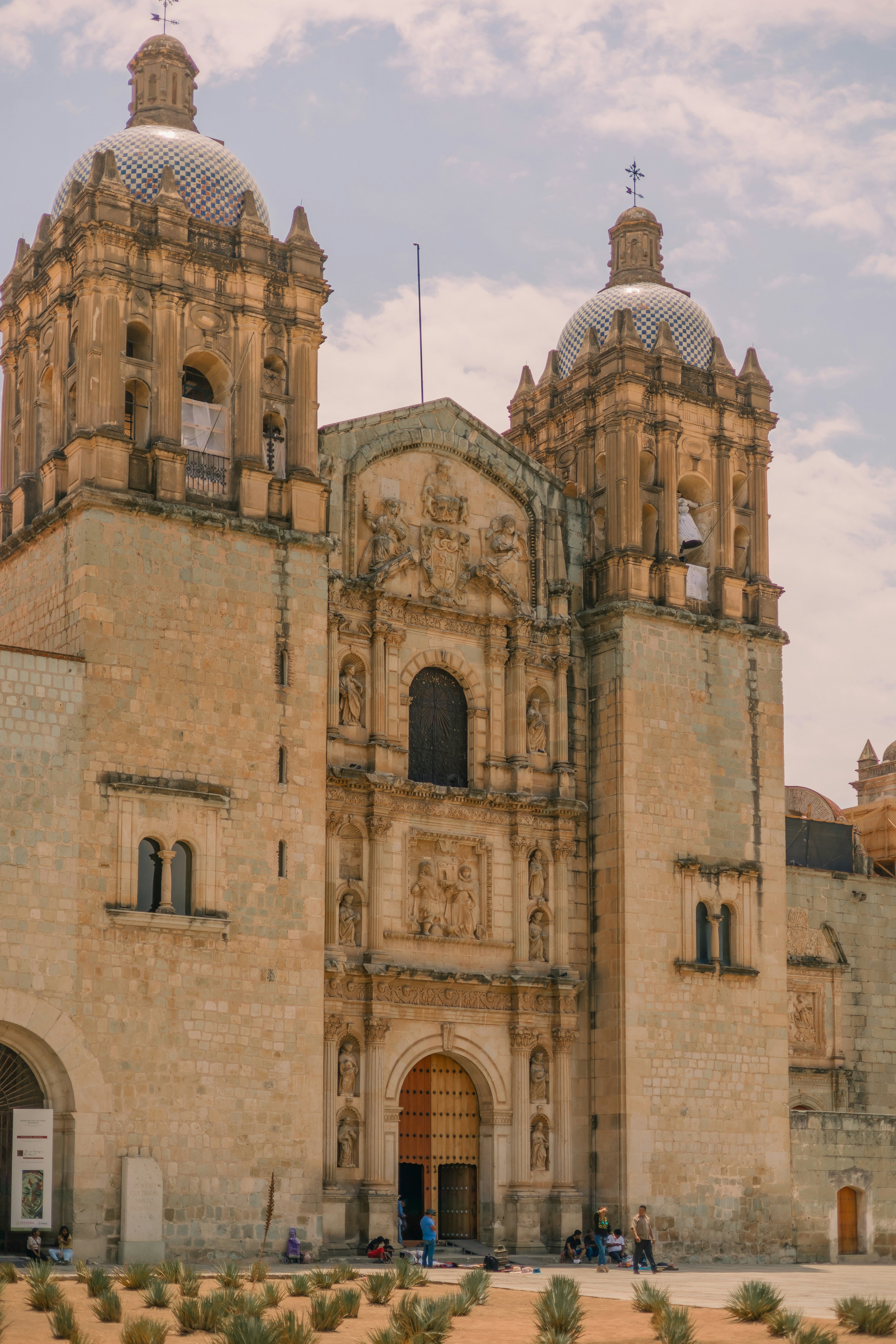 Facade of a Sunlit Cathedral: Stone Carvings and Twin Domes