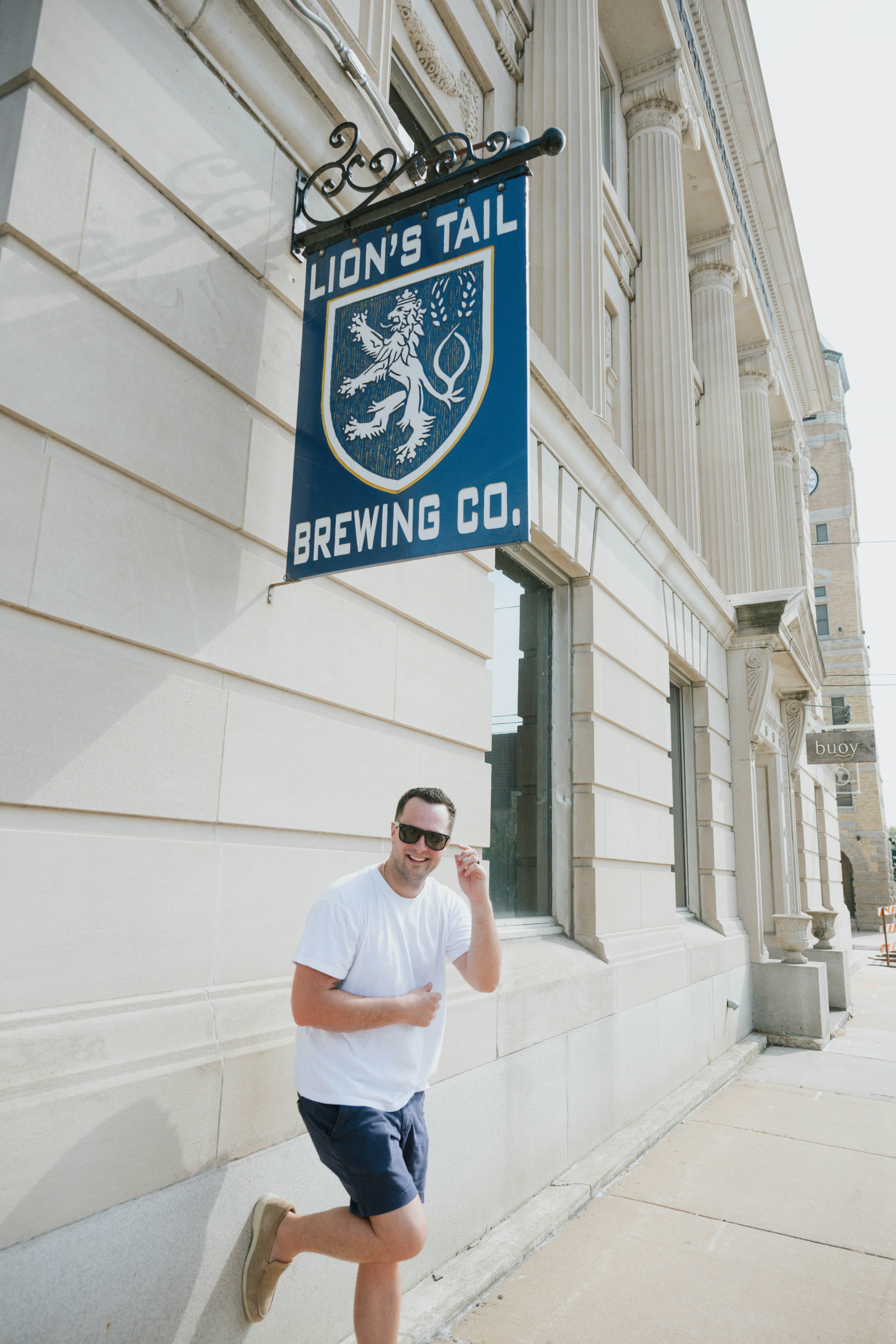 Sunlit Stroll by Lion's Tail Brewing Co.: A Casual Portrait on the City Walk