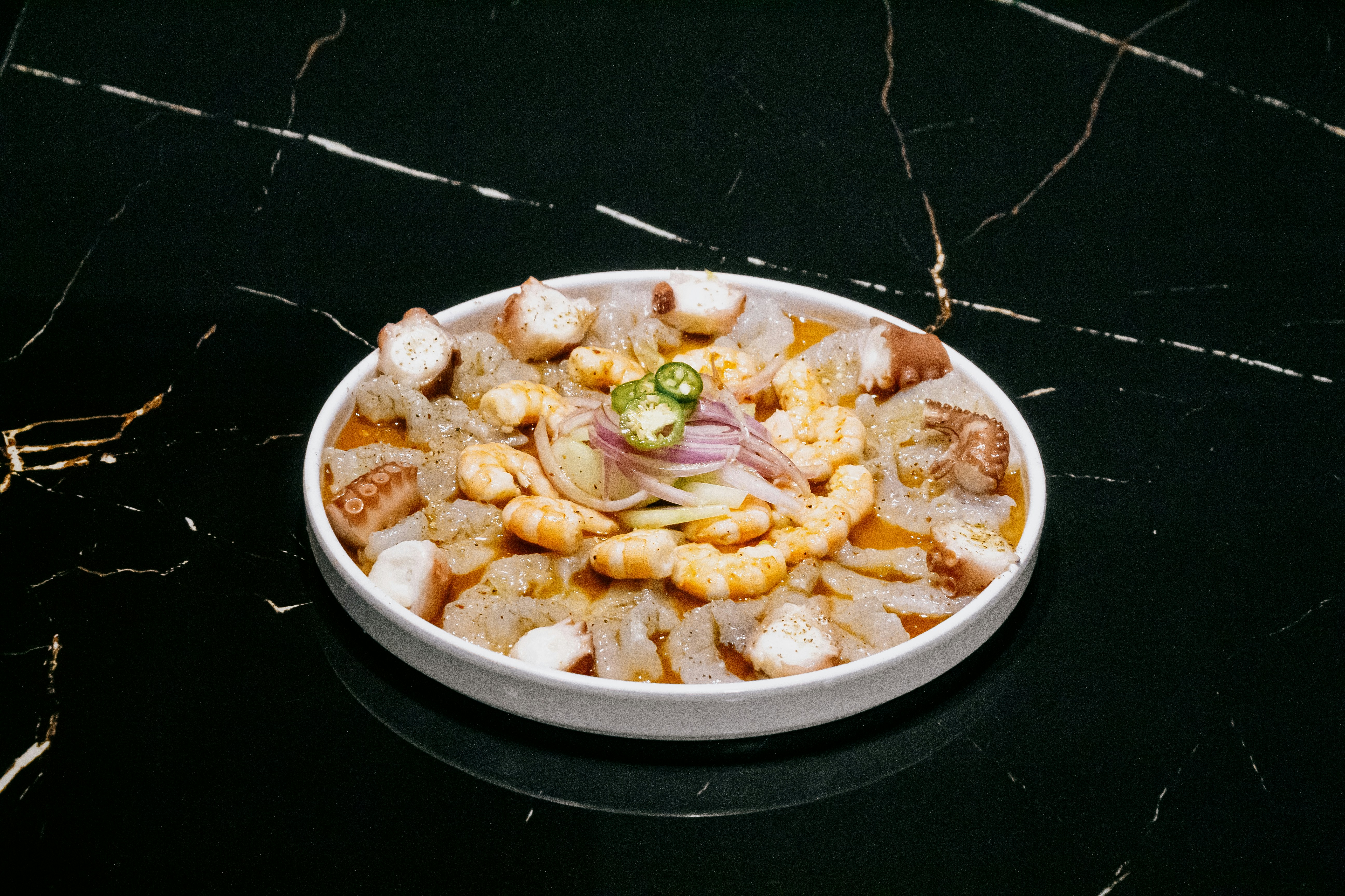Midnight Marble Seafood Plate: Shrimp, Squid, and Onion in a Glossy Broth