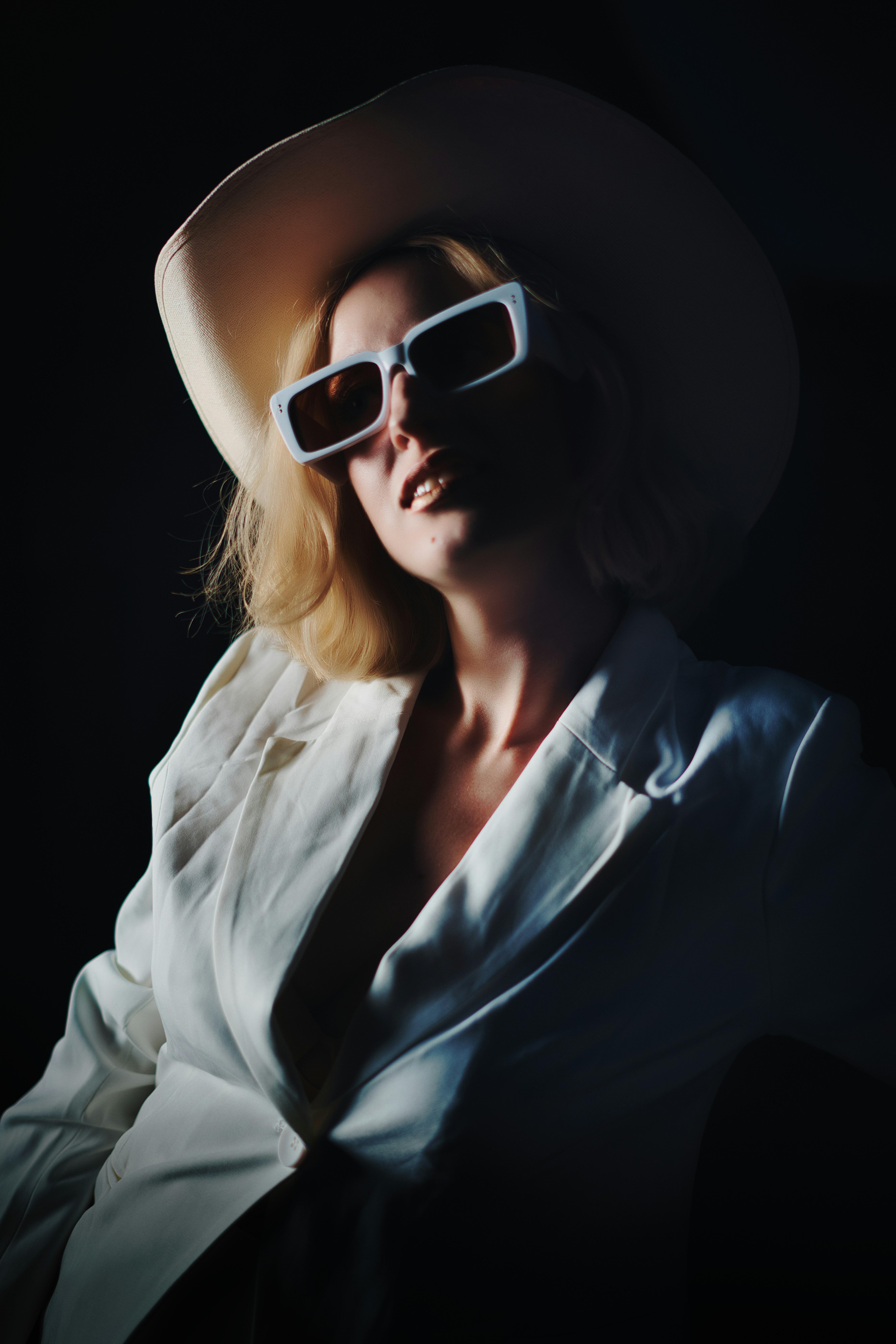 Noir Glimmer: A Side-Lit Portrait of Silk, Shadow, and Sunglasses
