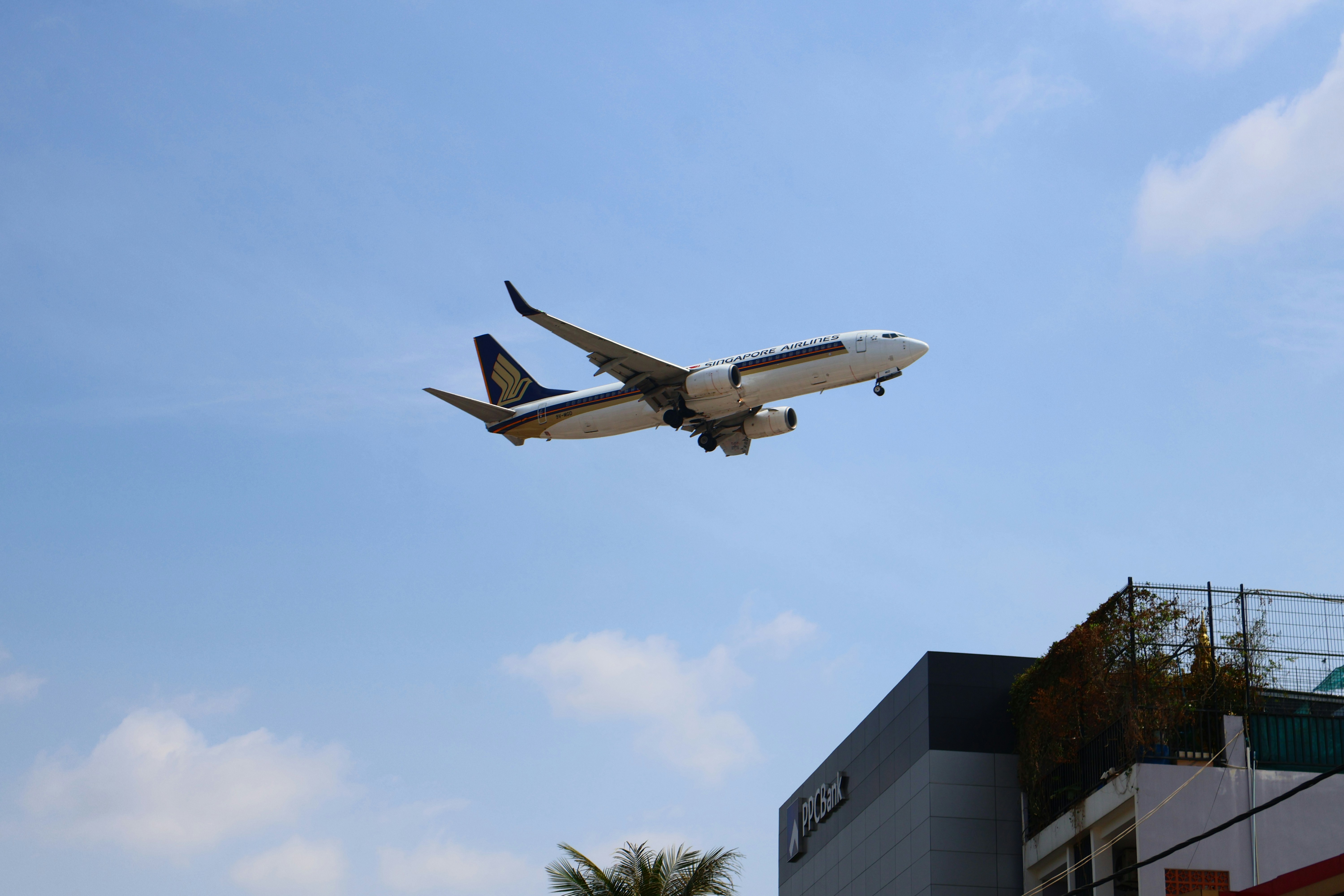 A large jetliner flying through a blue sky photo – Free Airplane Image ...