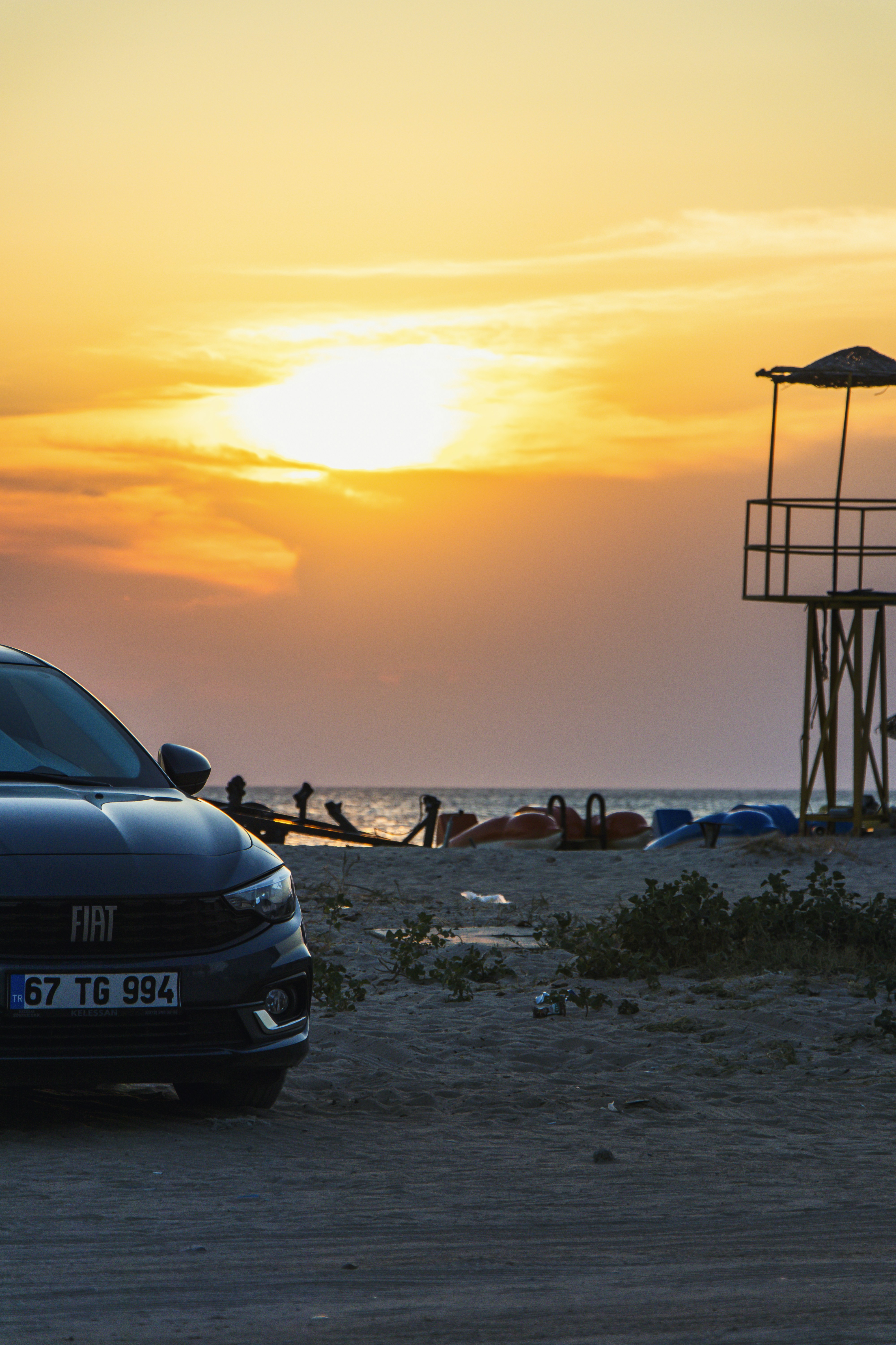 Sunset Parking by the Quiet Sea: Fiat at Dusk Beside a Lifeguard Tower