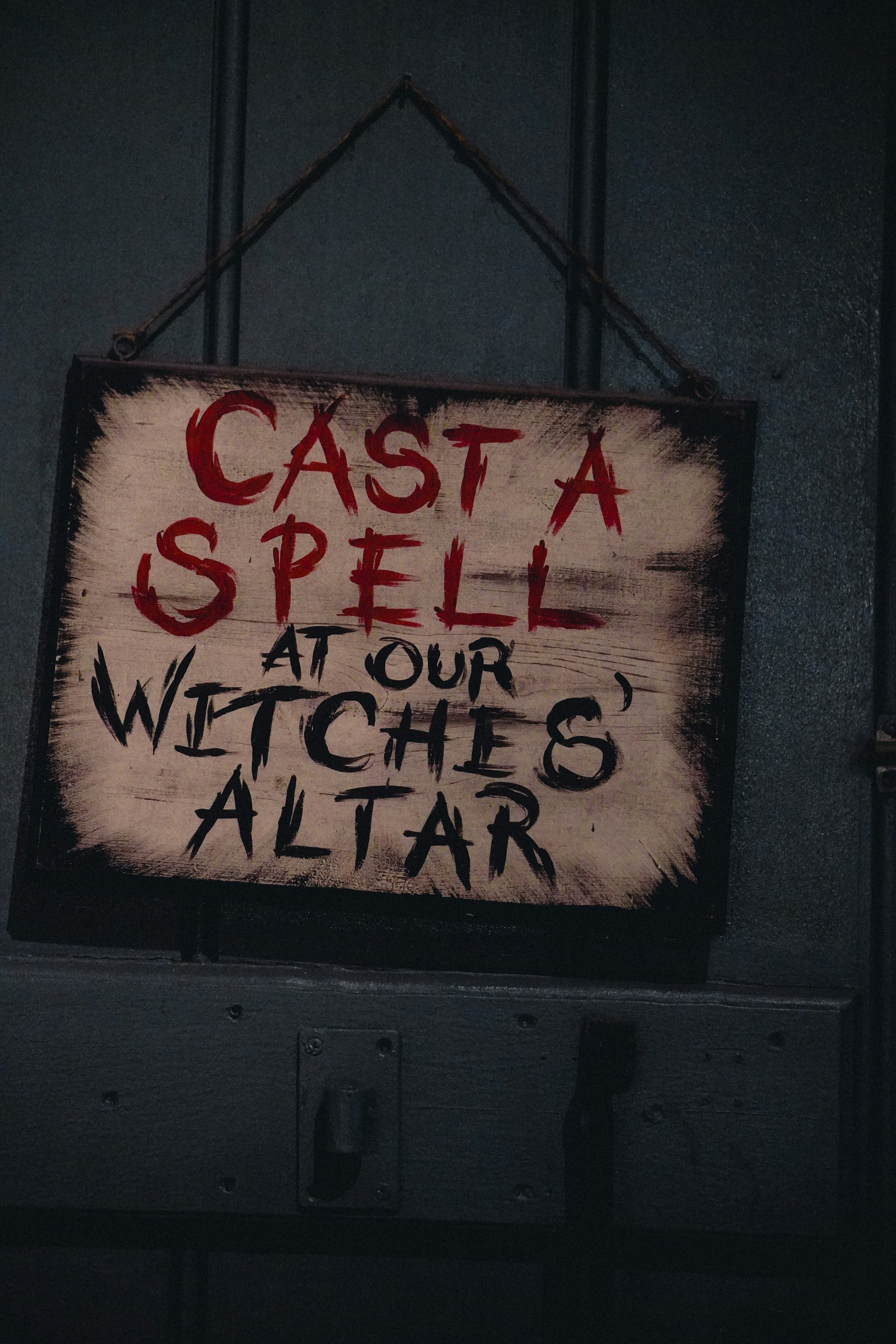 Casting a Spell: Worn Sign Reading Aloud at a Witch's Altar