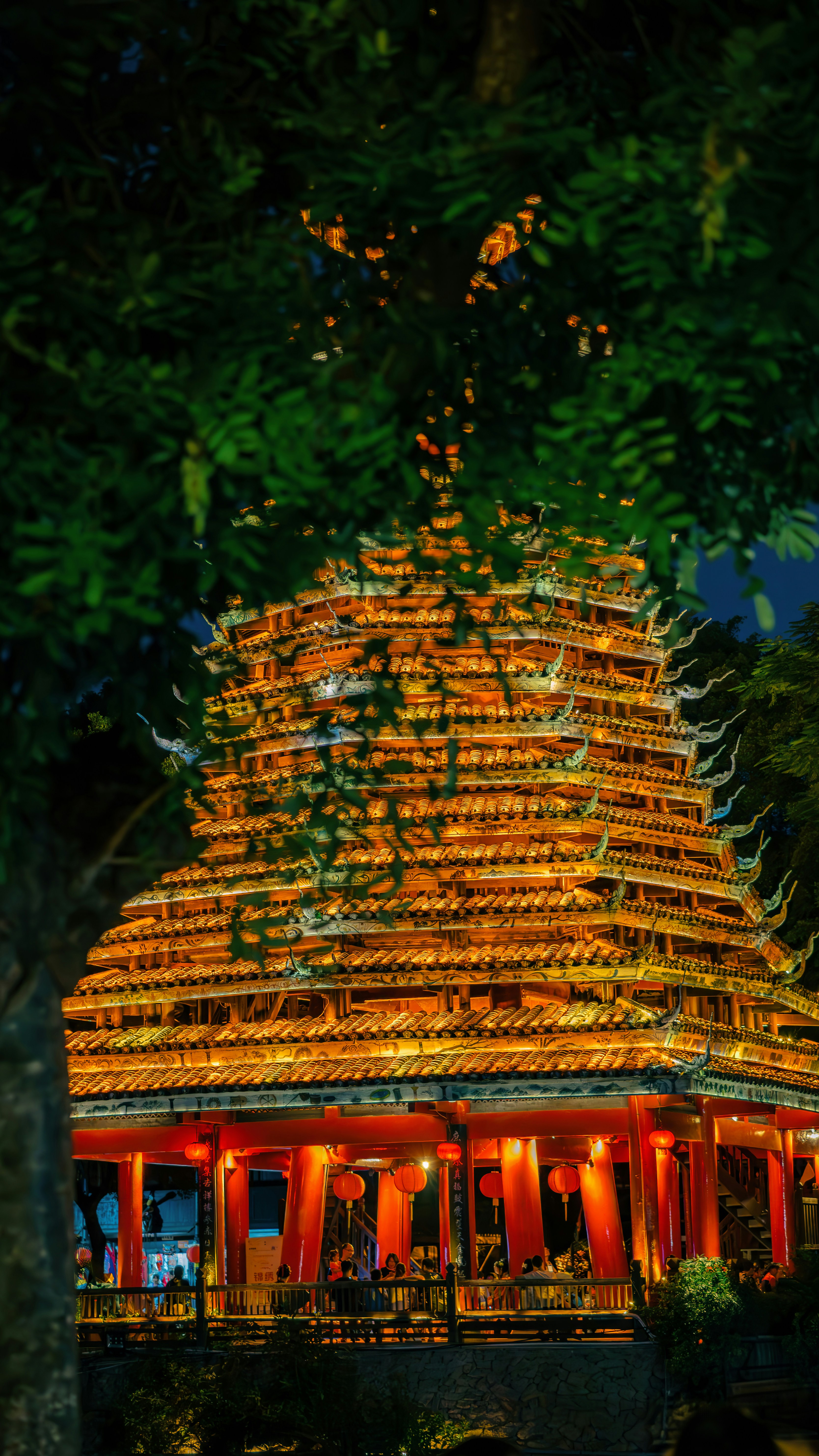 Night-Gilded Pagoda Rising Through a Curtain of Leaves