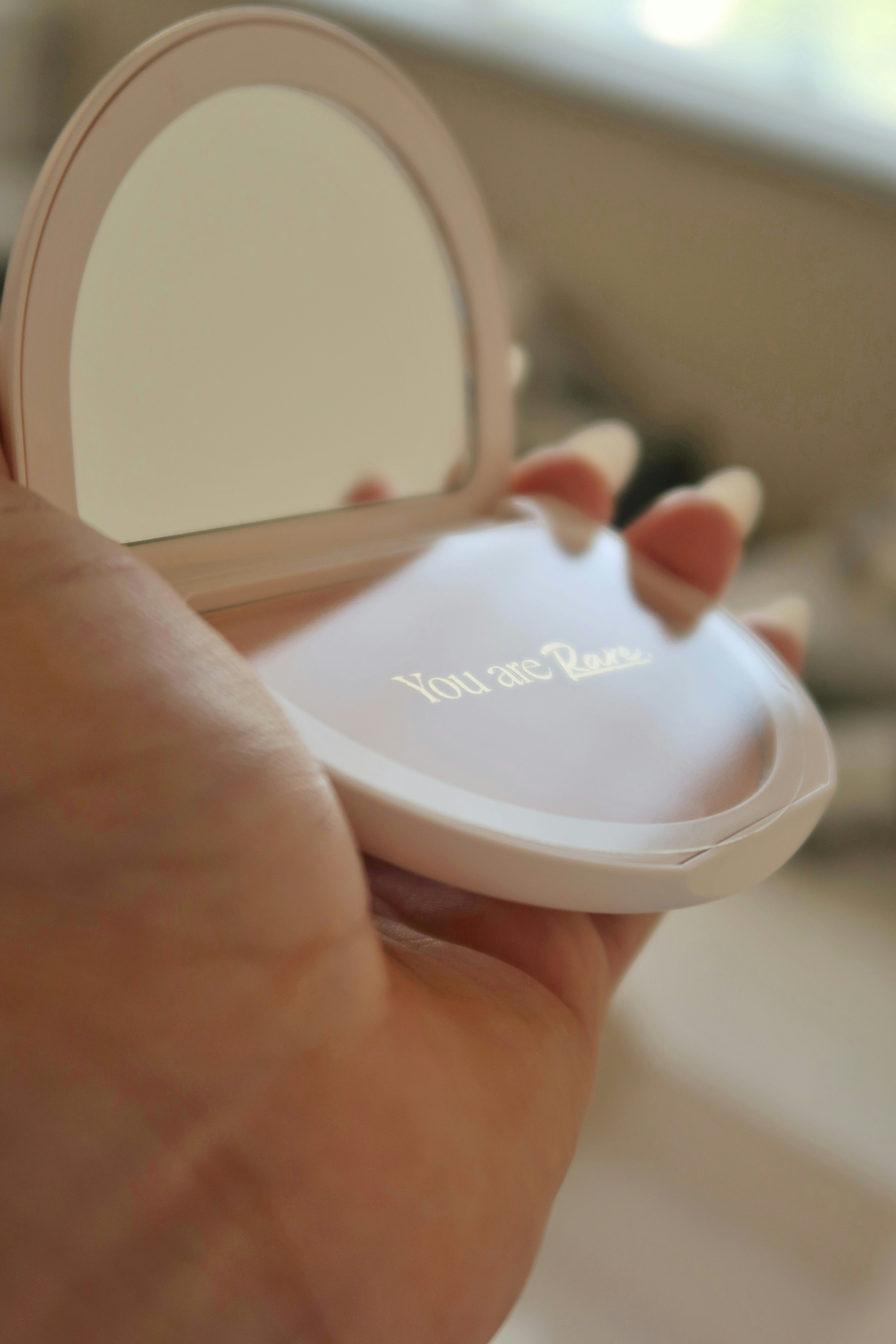 Whispered Affirmation Close-Up: A Gentle Pink Compact