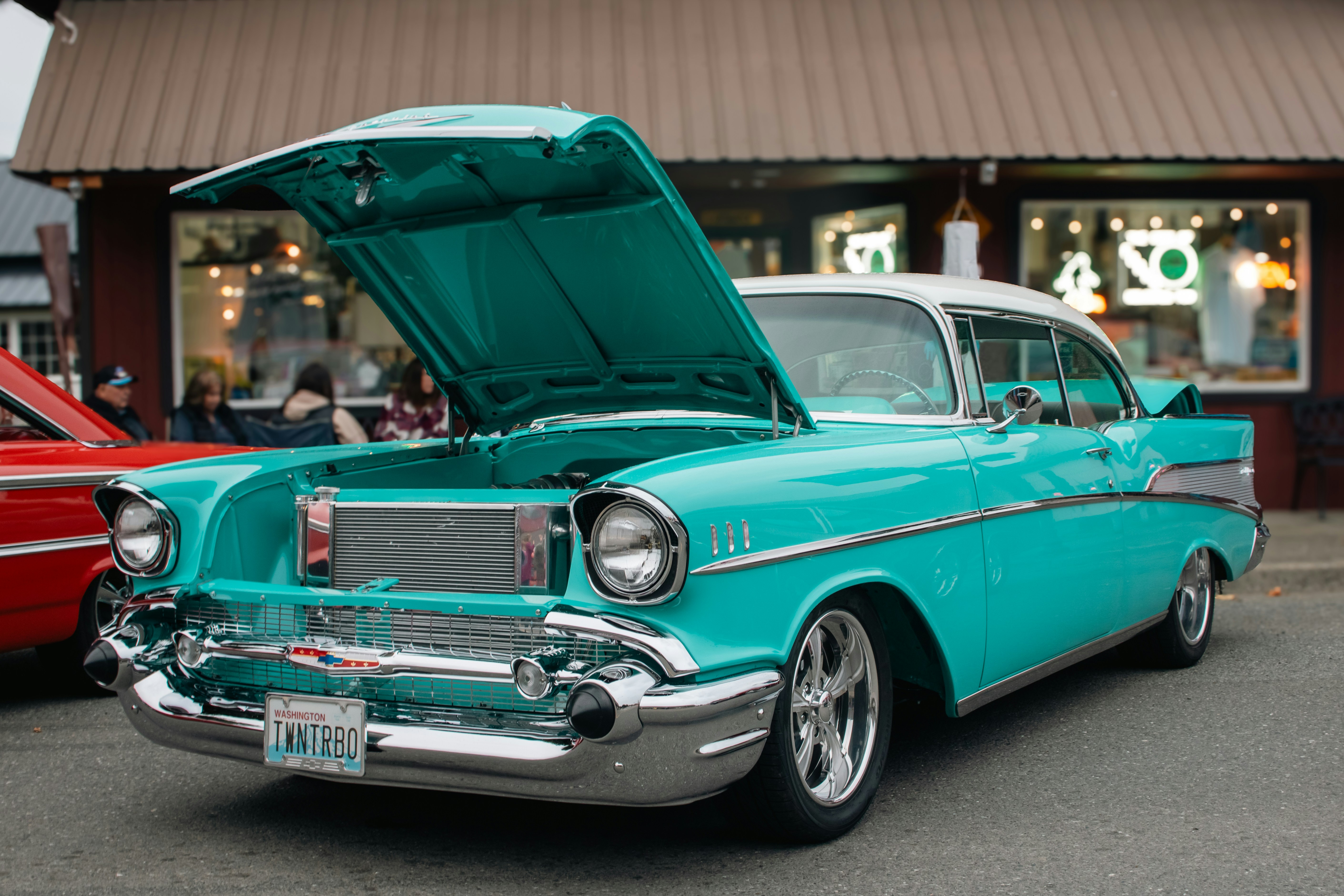 A turquoise car with a hood open in a parking lot photo – Free Forks ...