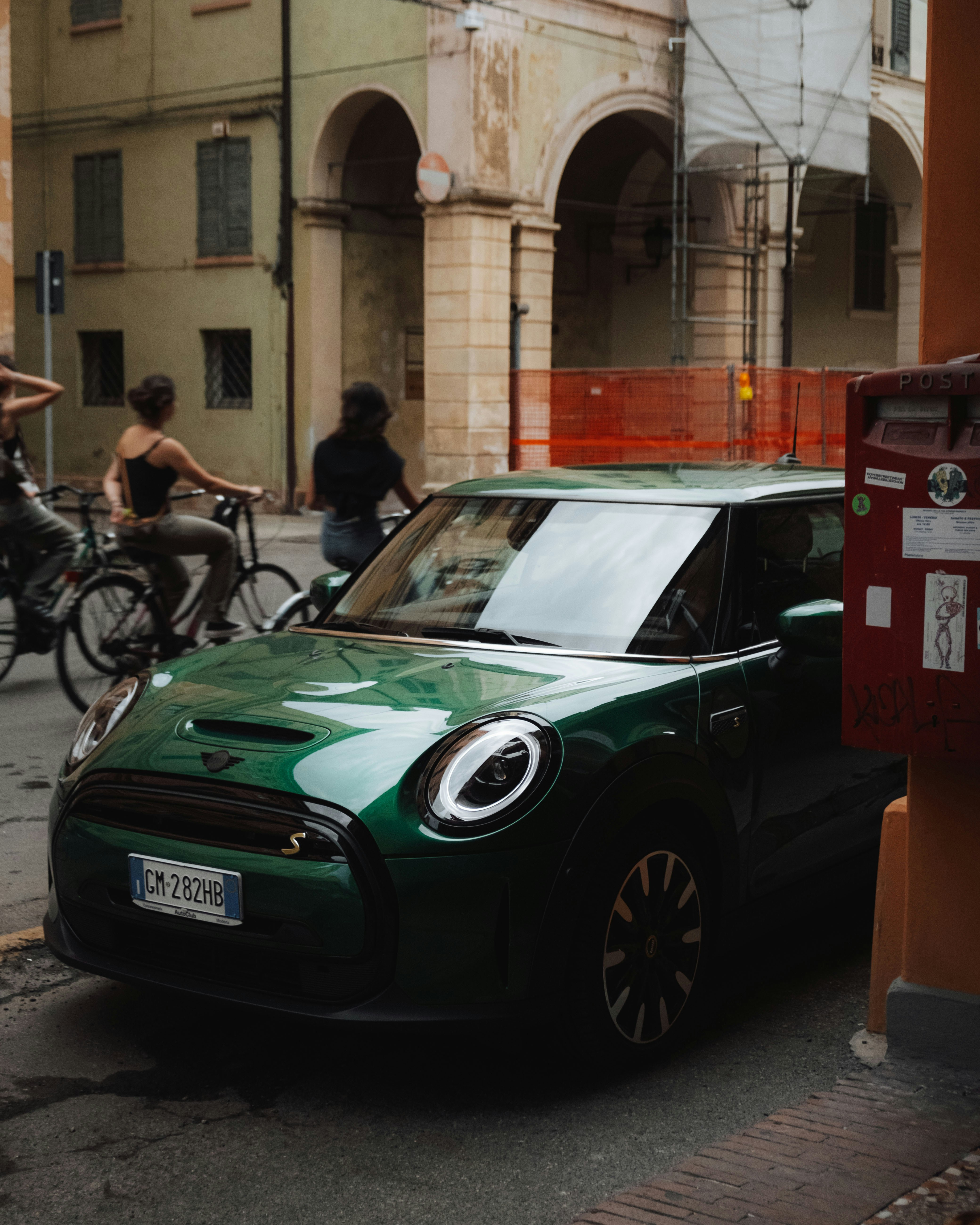 A small green car parked on the side of the road photo – Free Italy ...