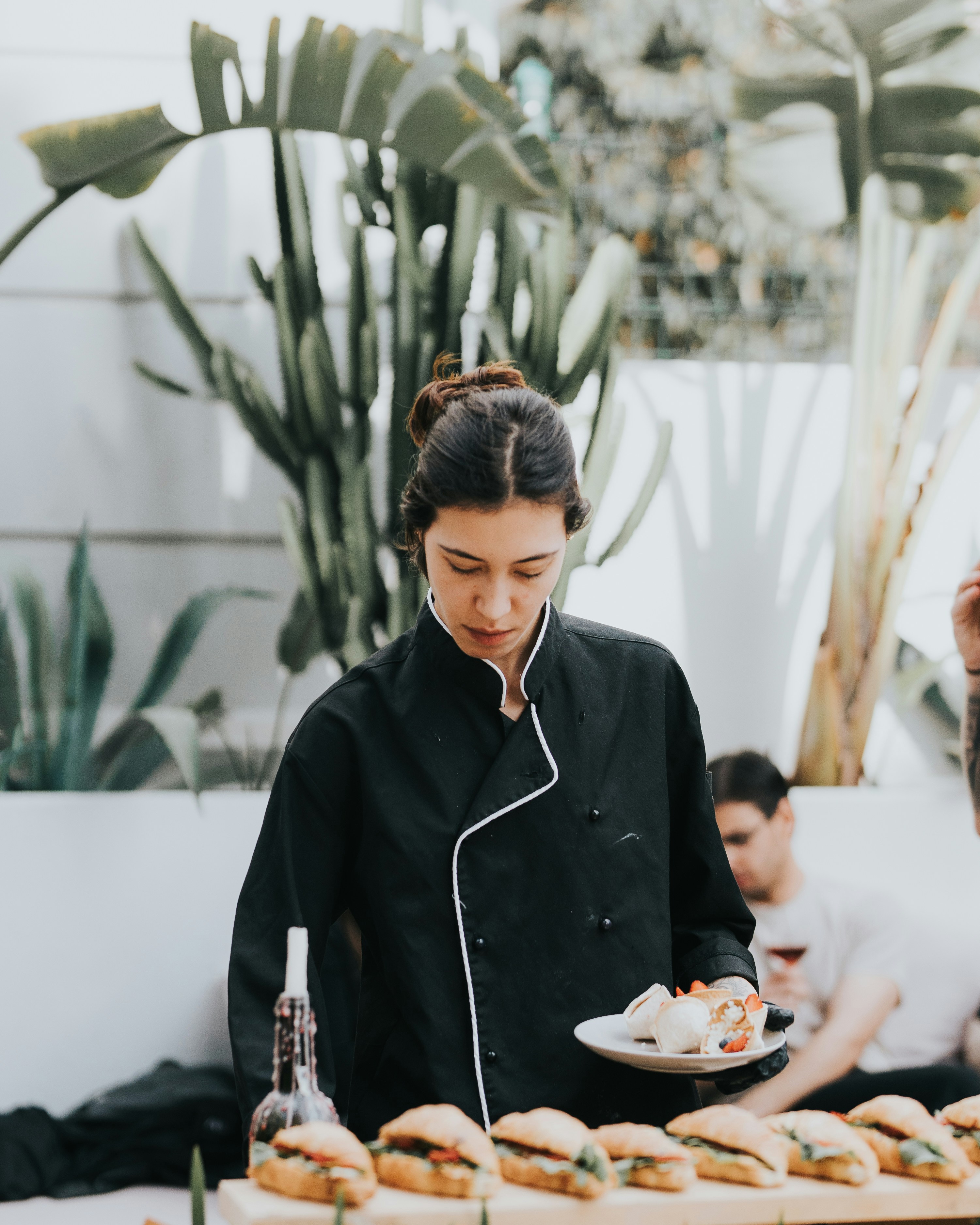 Plating Pulse: The Chef's Hand Guides a Row of Sandwiches