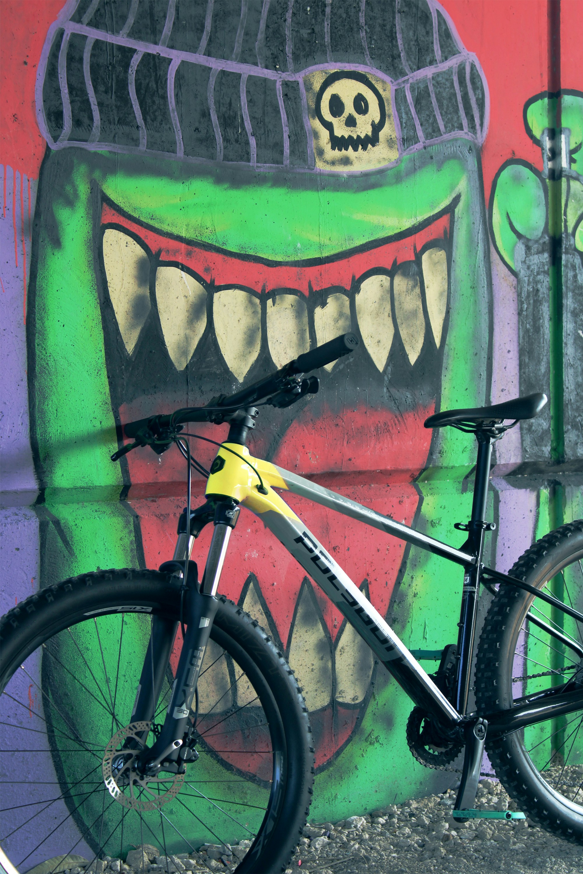 An XC bike standing on a graffiti wall