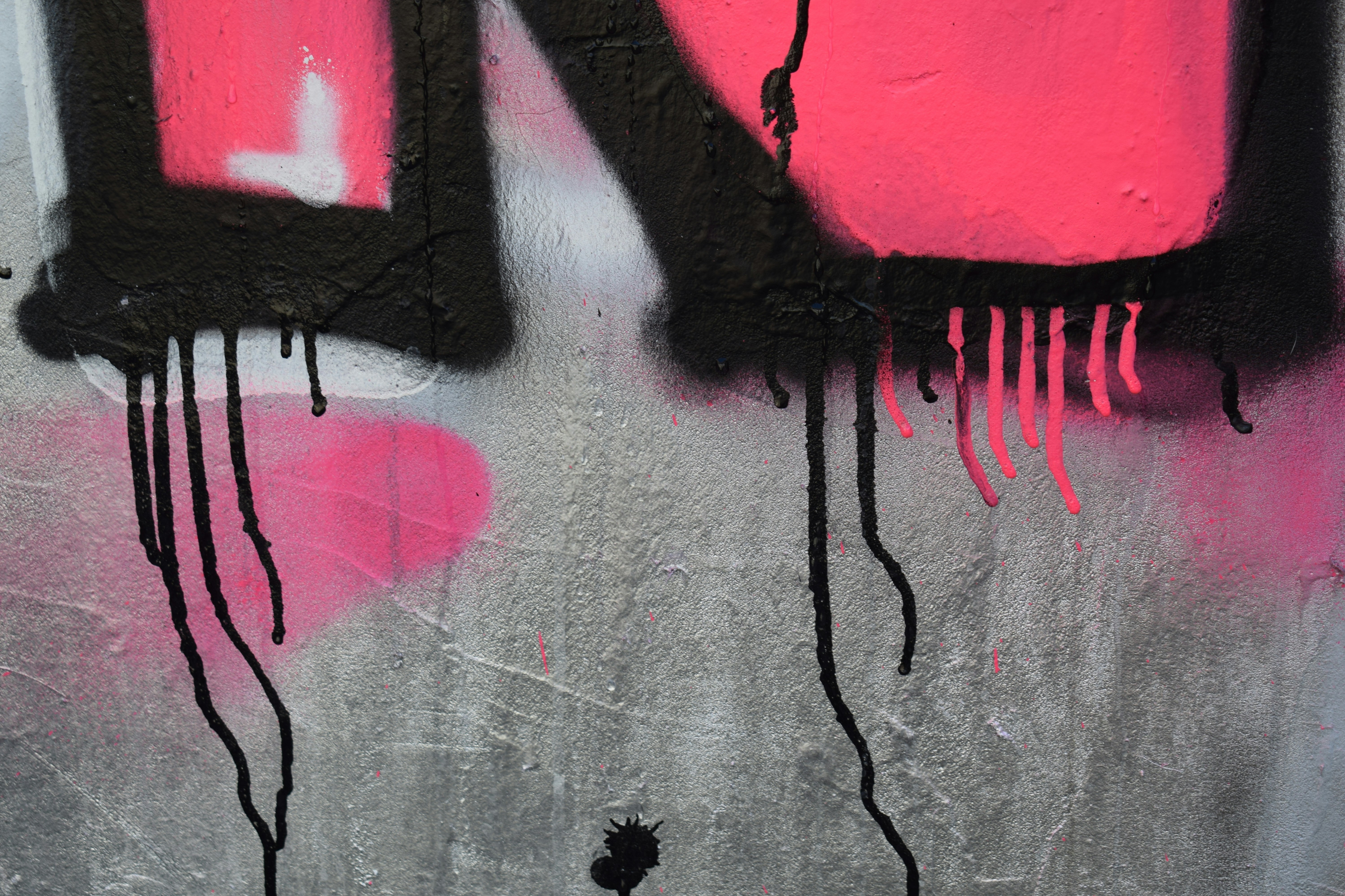 A wall with some pink and black graffiti on it photo – Free Woman Image ...