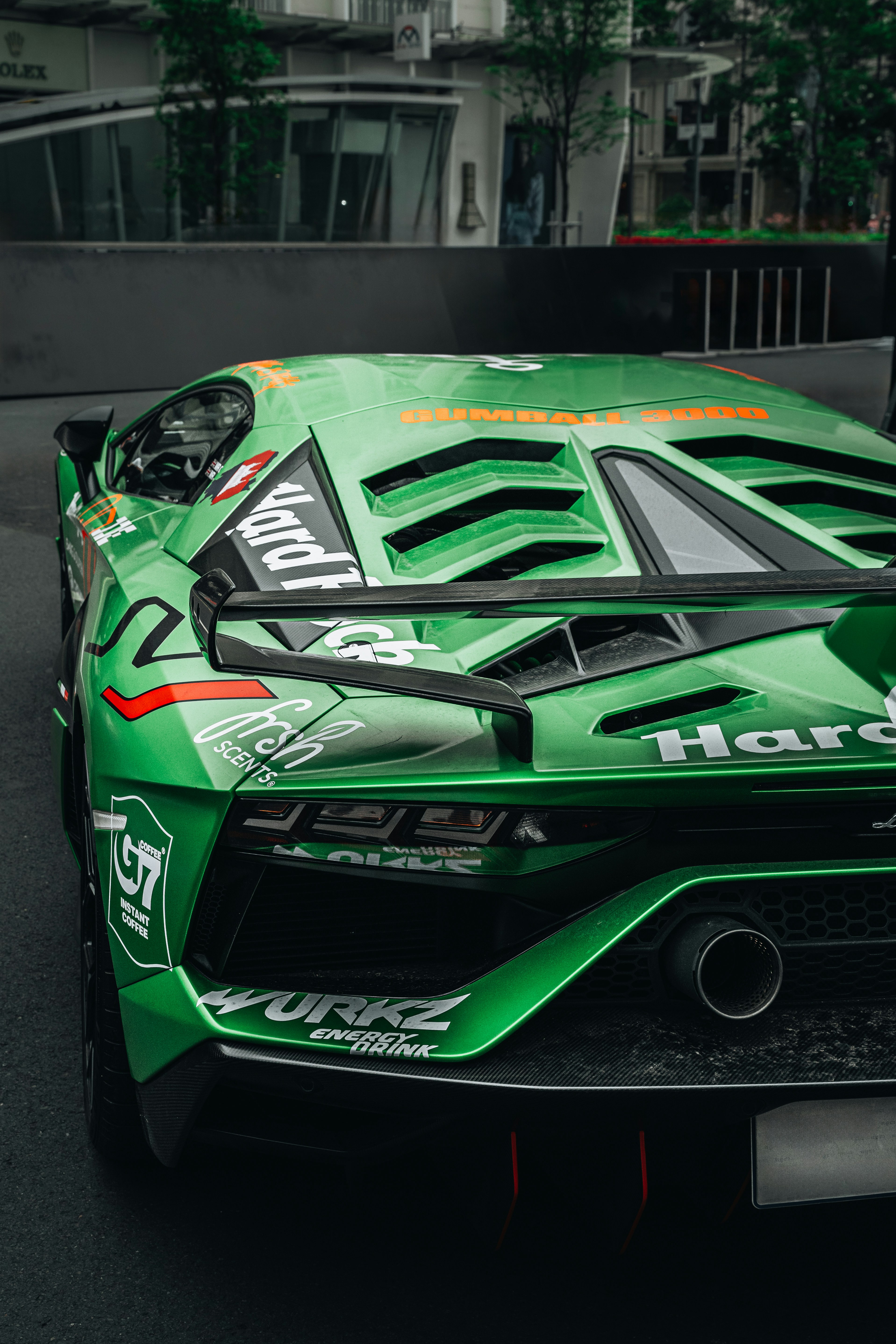 A green race car driving down a race track photo – Free Hồ chí minh ...