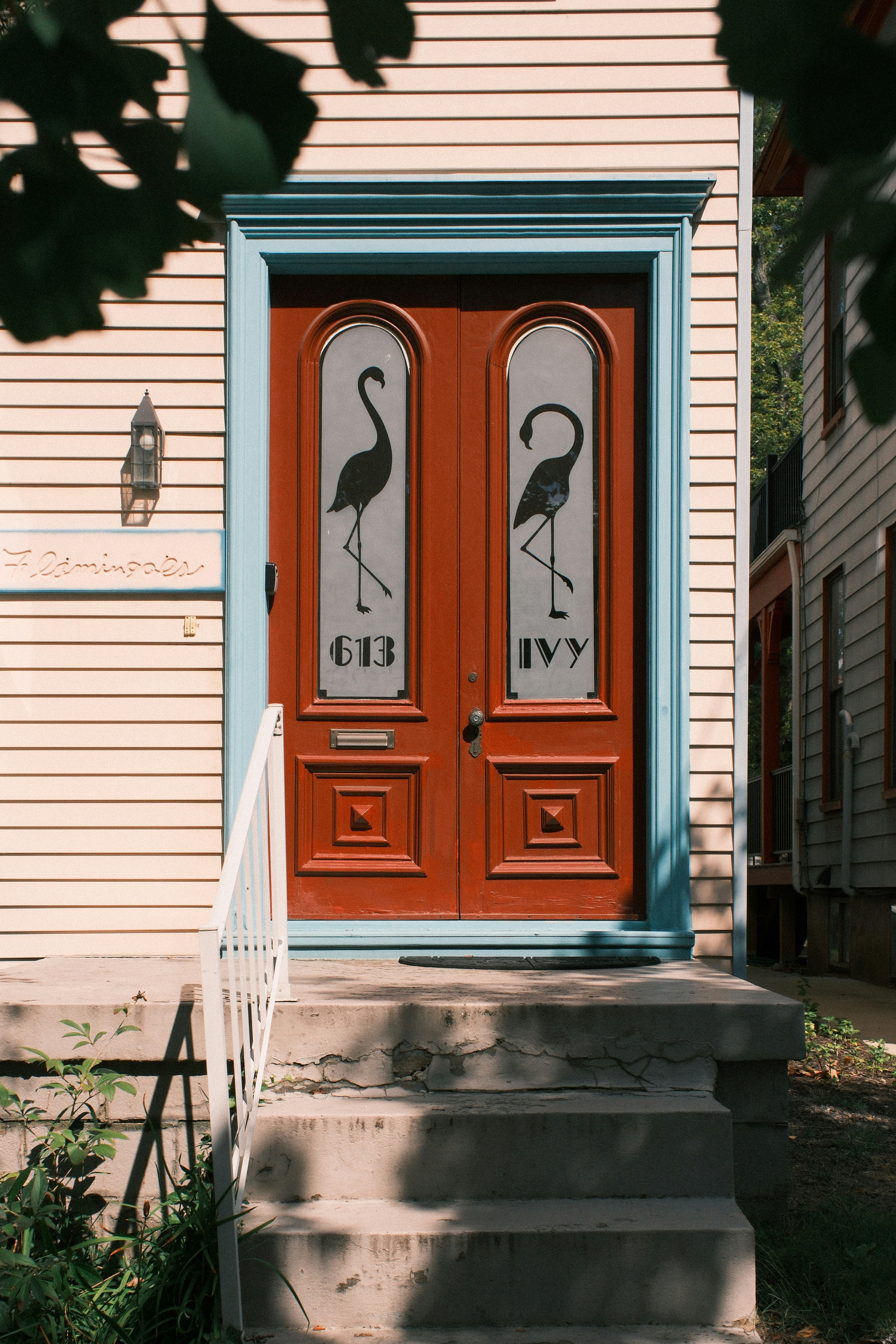 Red Door Portrait: Heron Silhouettes Framed by Turquoise Trim