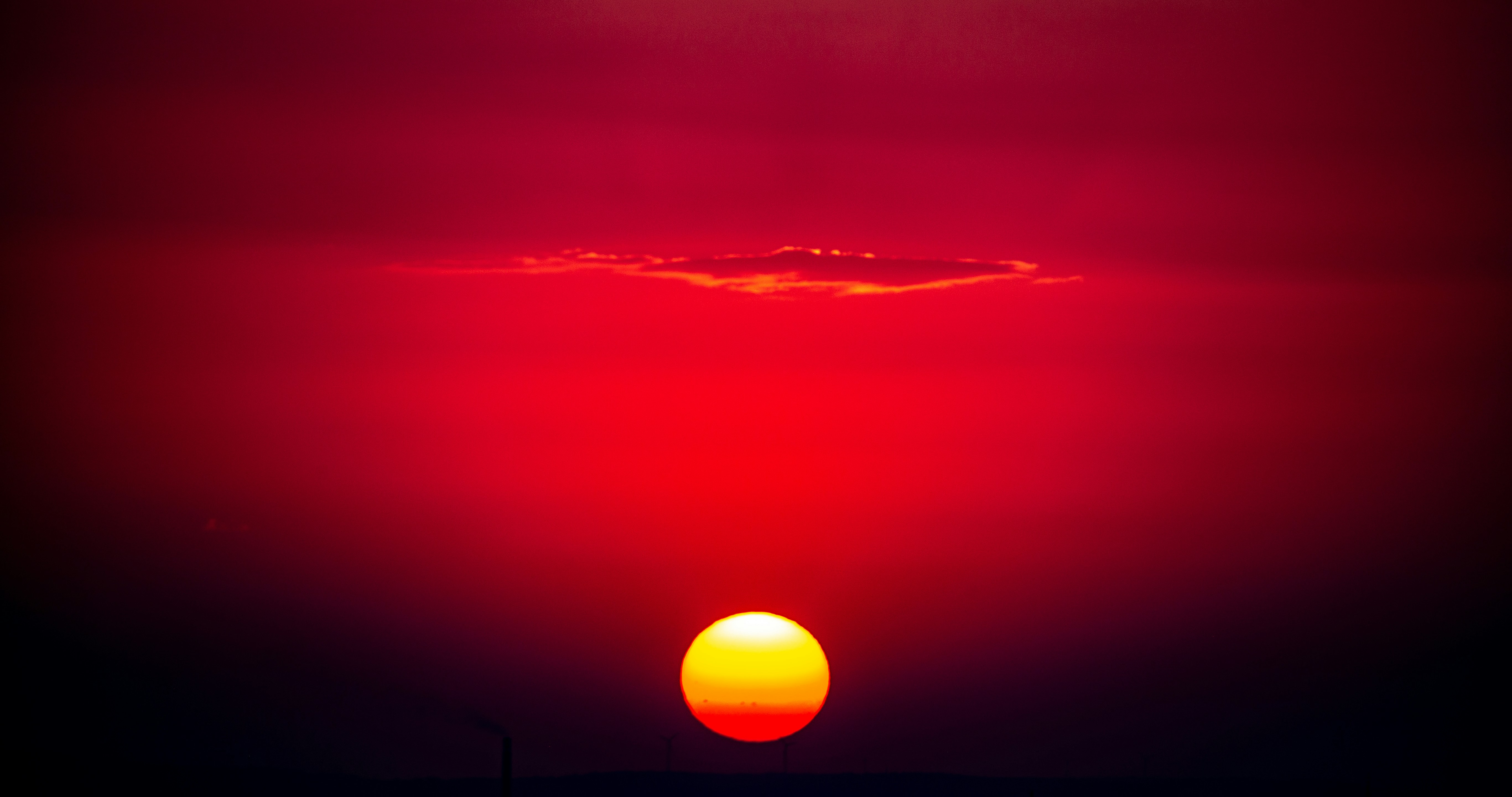 The sun is setting over the horizon of a body of water photo – Free ...