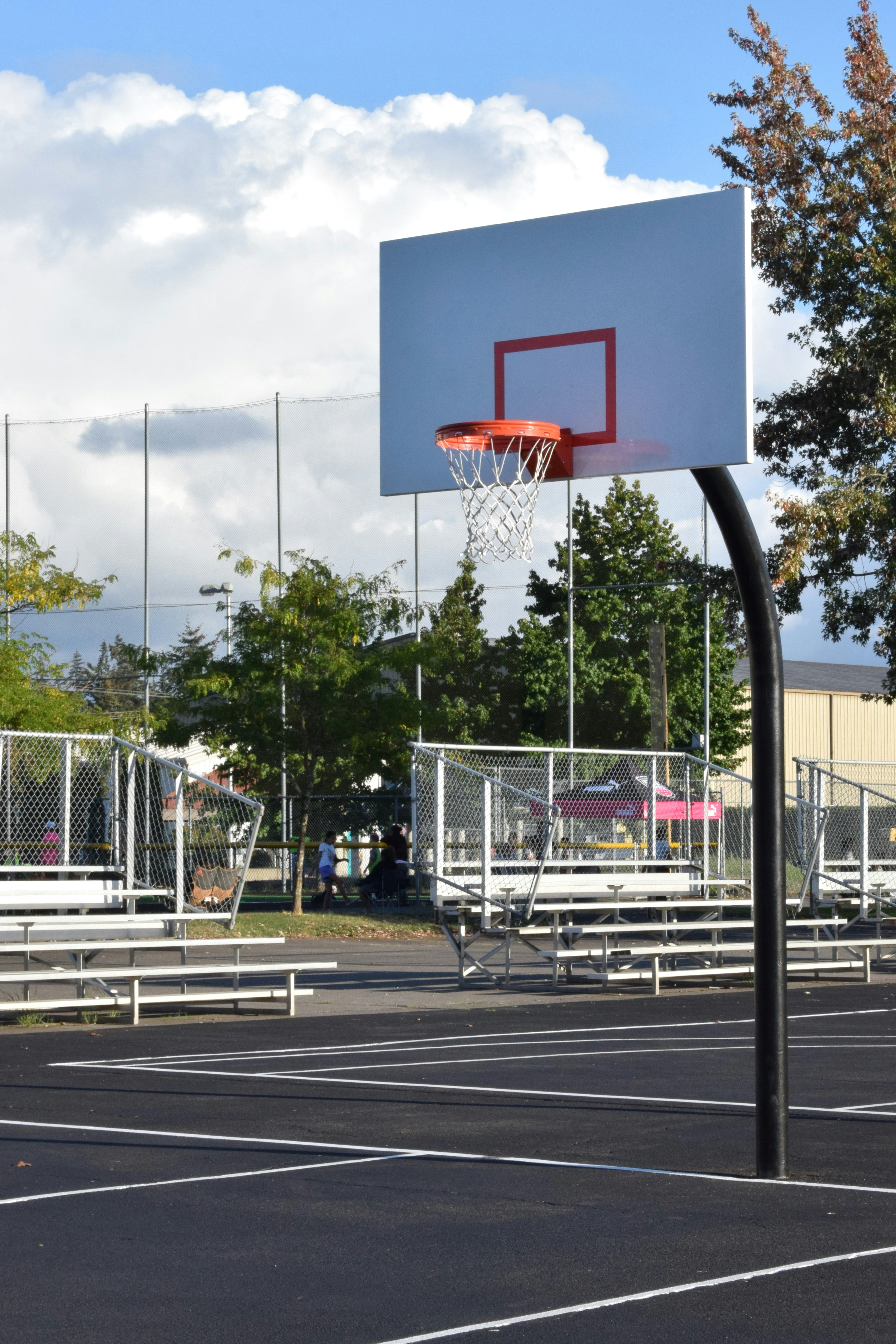 Basketball Court in Sunlit Park: Hoop as Urban Anchor