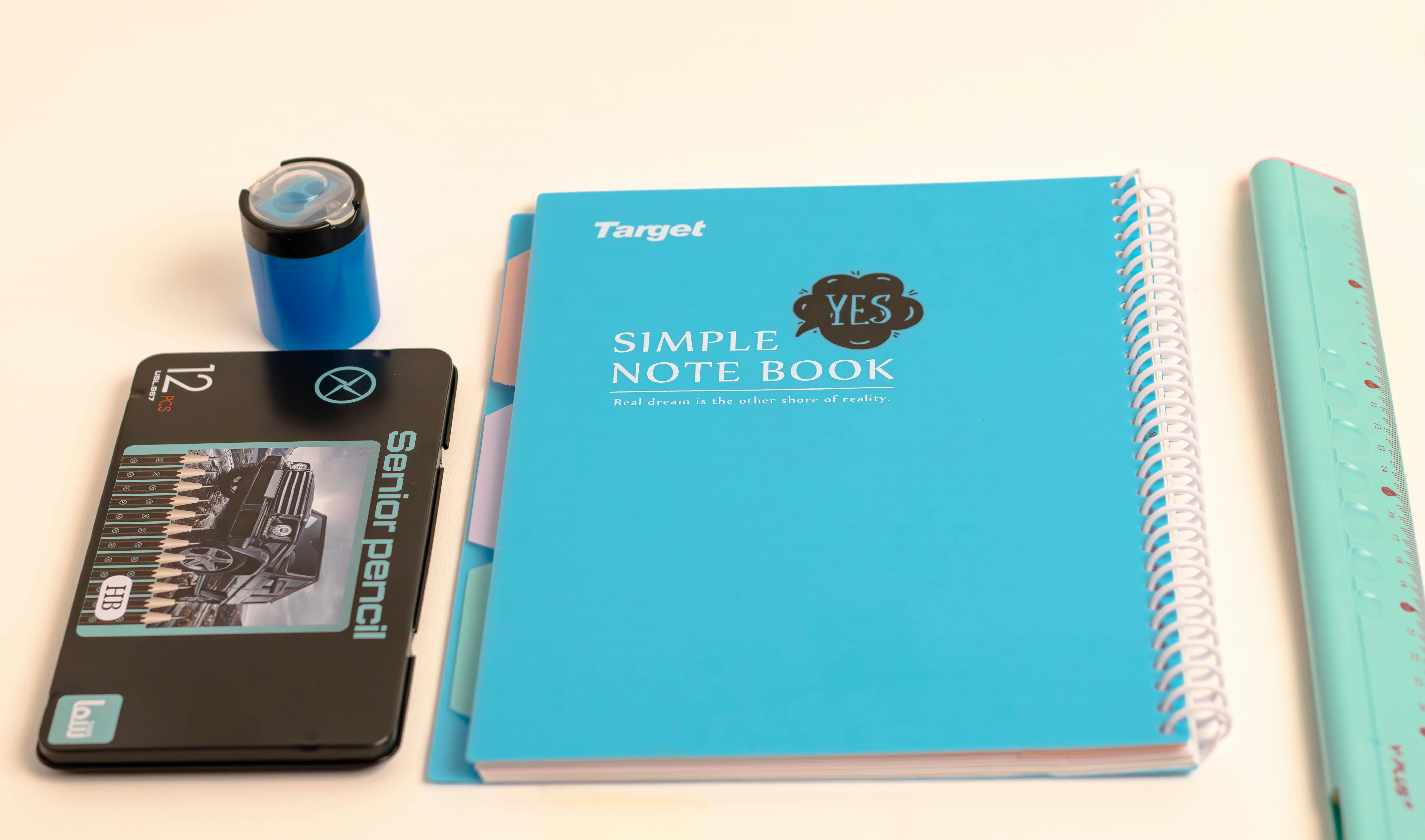 A note book, pen, and lighter on a table photo – Free Copybook Image on ...