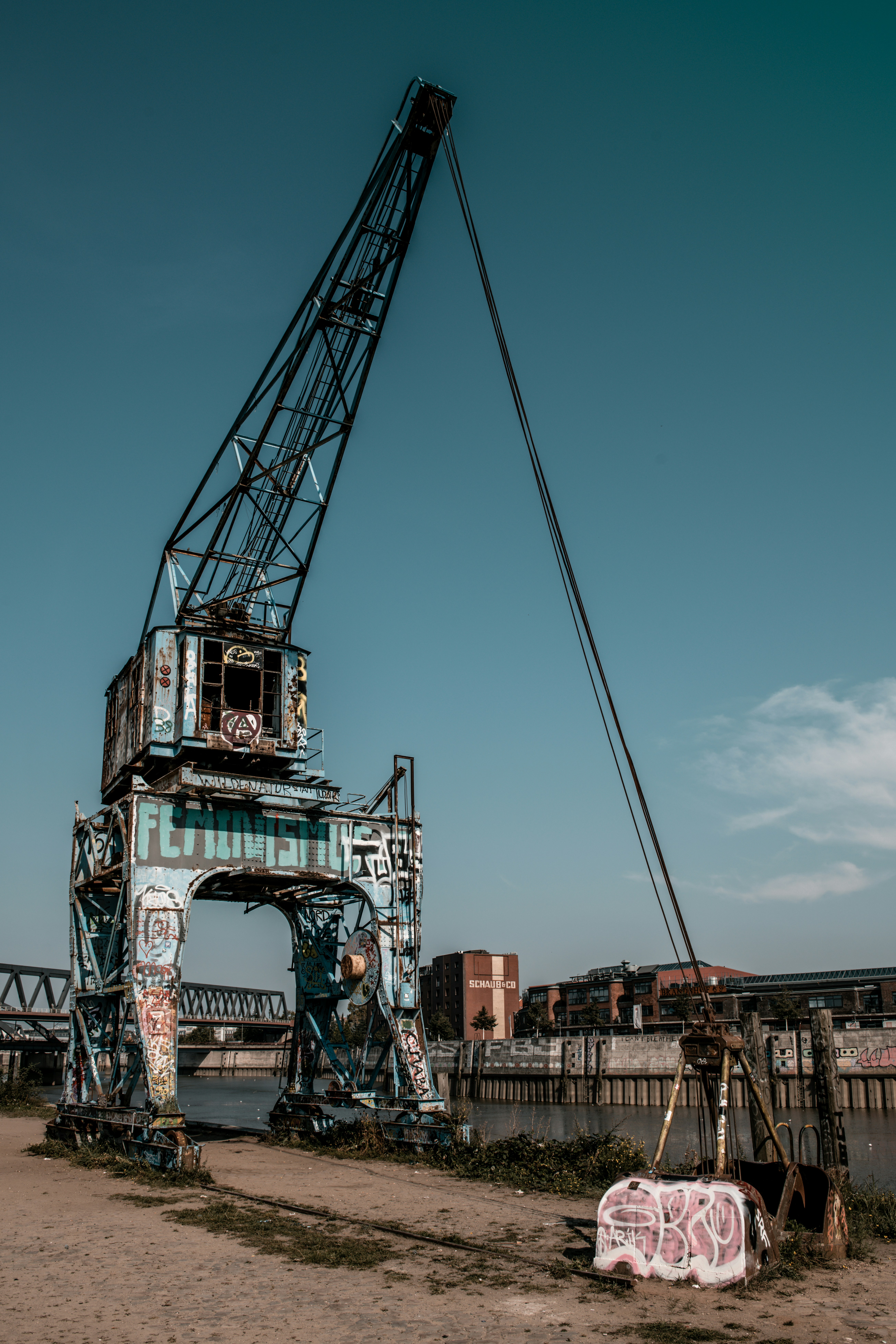 Rusty Harbor Crane under a Crisp Blue Sky