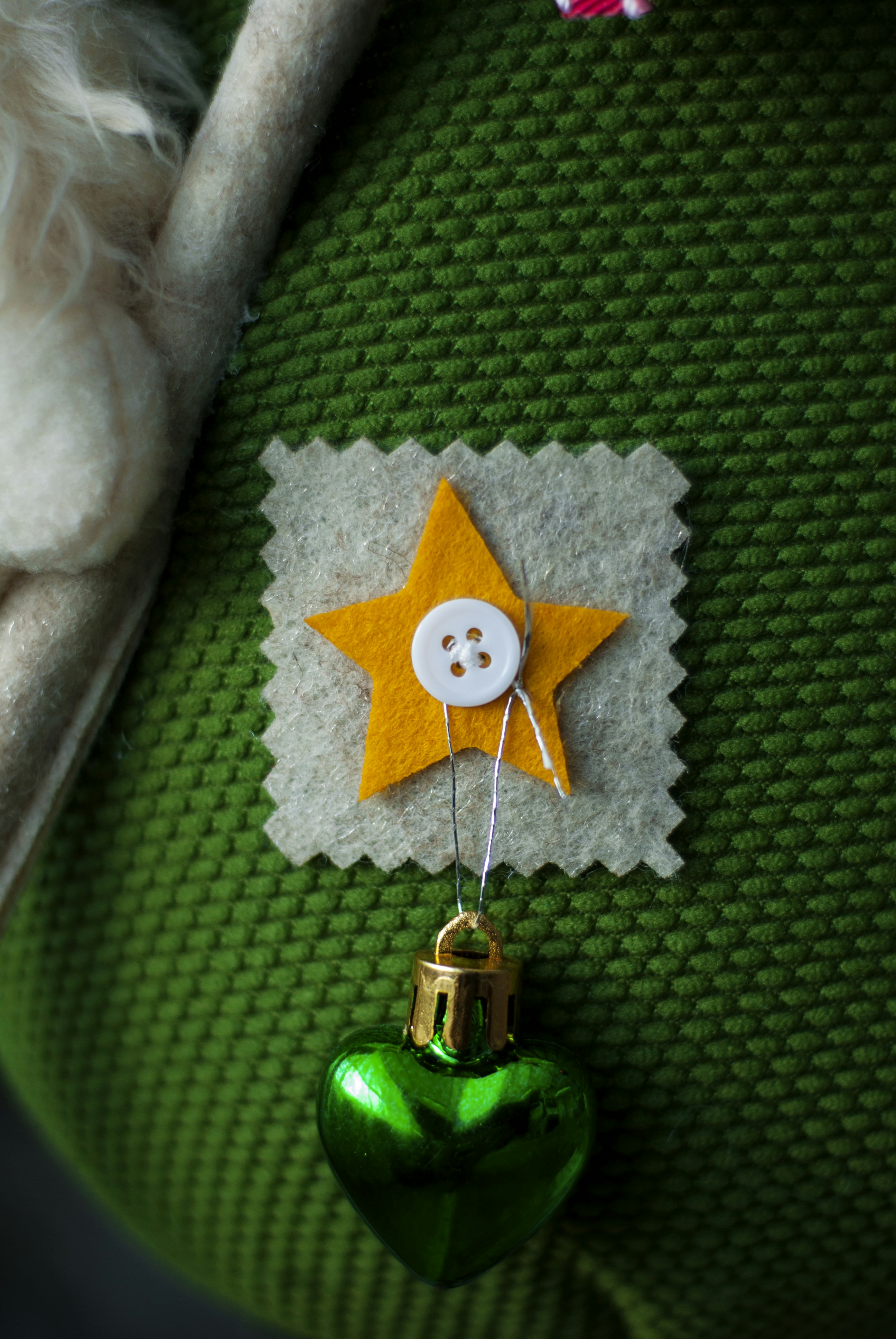 Patchwork Star and Button: A Tiny Ornament Dangles on Felt Over Knit