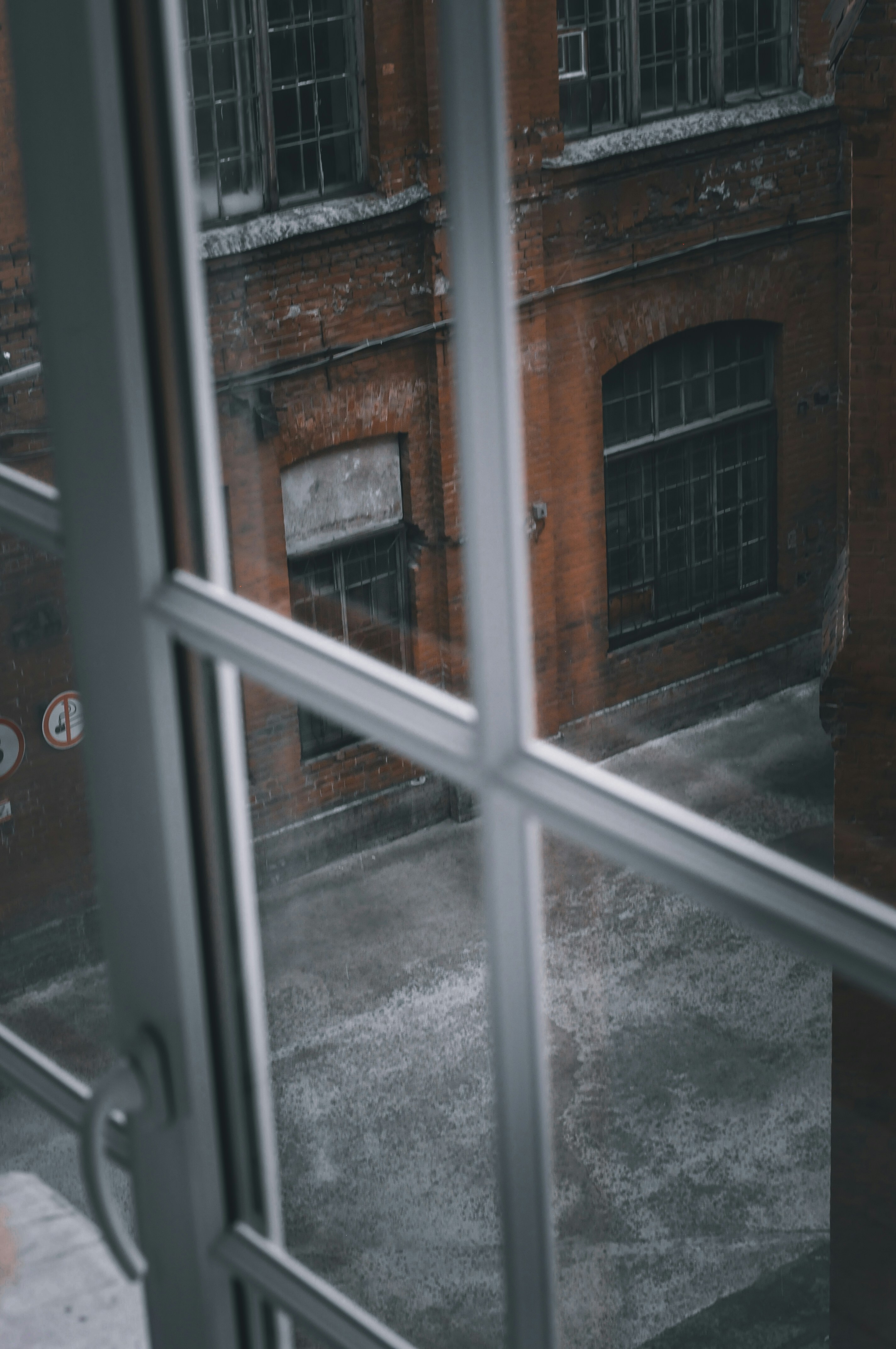 A view of a building through a glass window photo – Free Photo frame ...