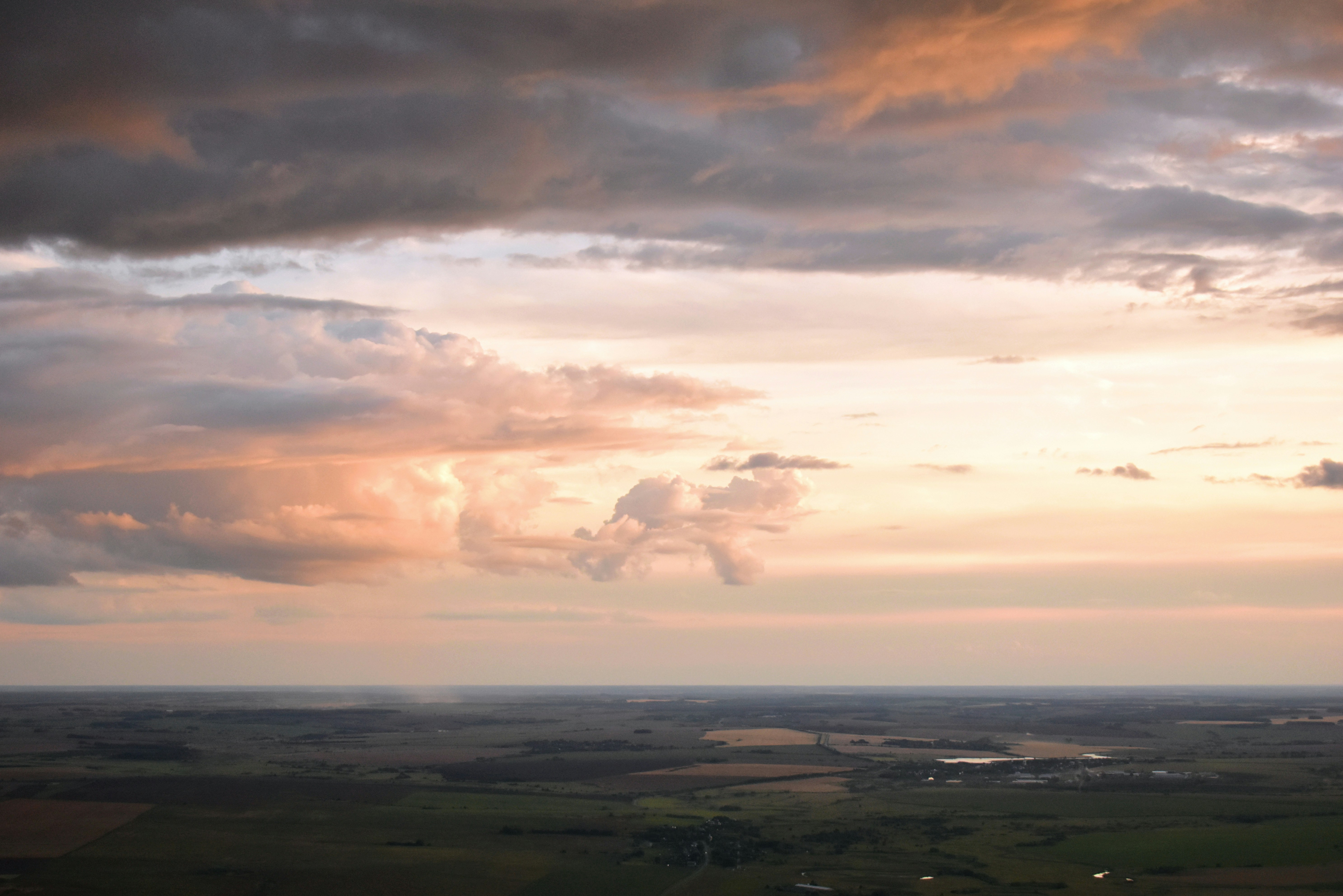 Dusk over the Quiet Plains: Amber Clouds and a Far Horizon