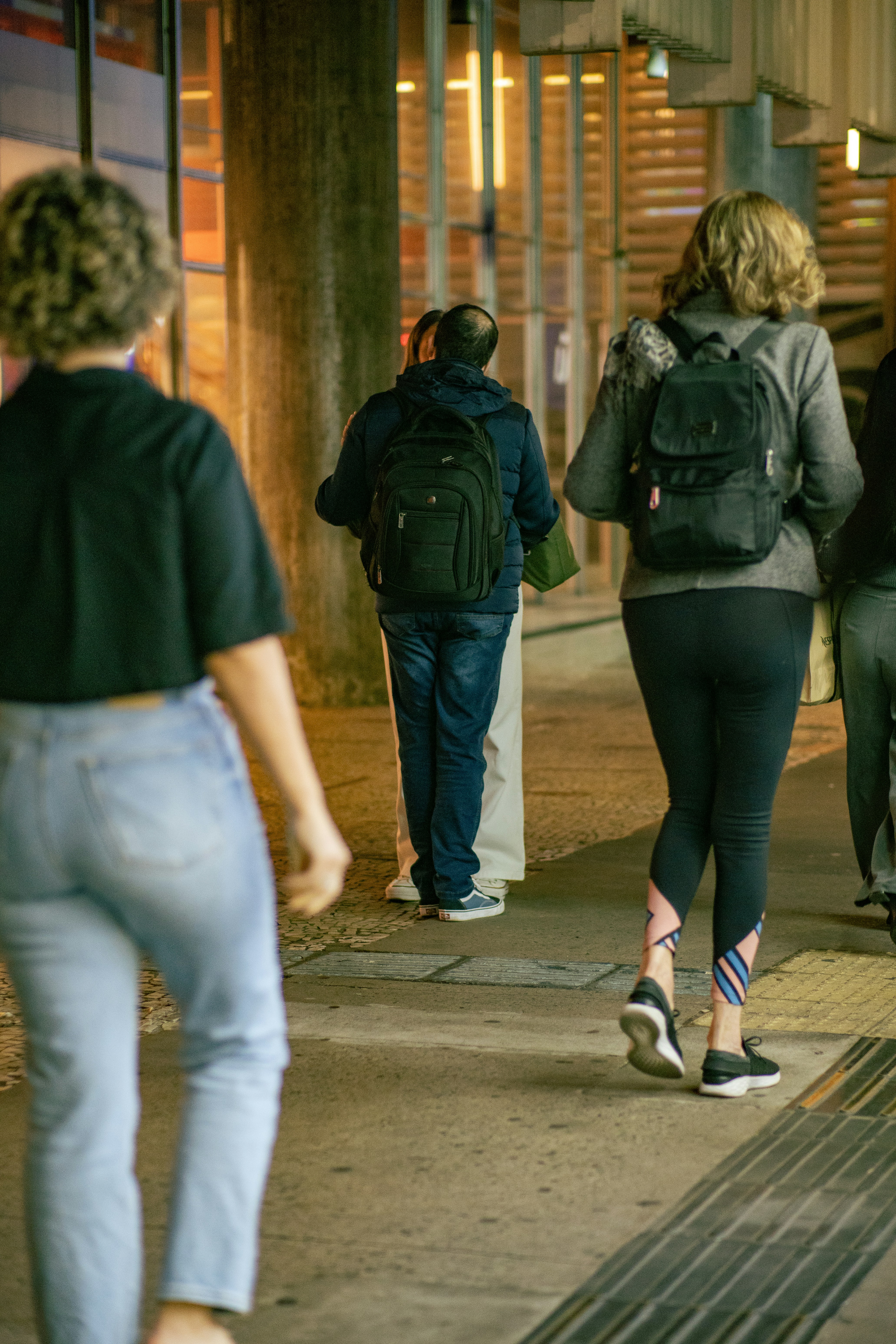 Backpack Parade in Neon Light: A Nighttime City Walk