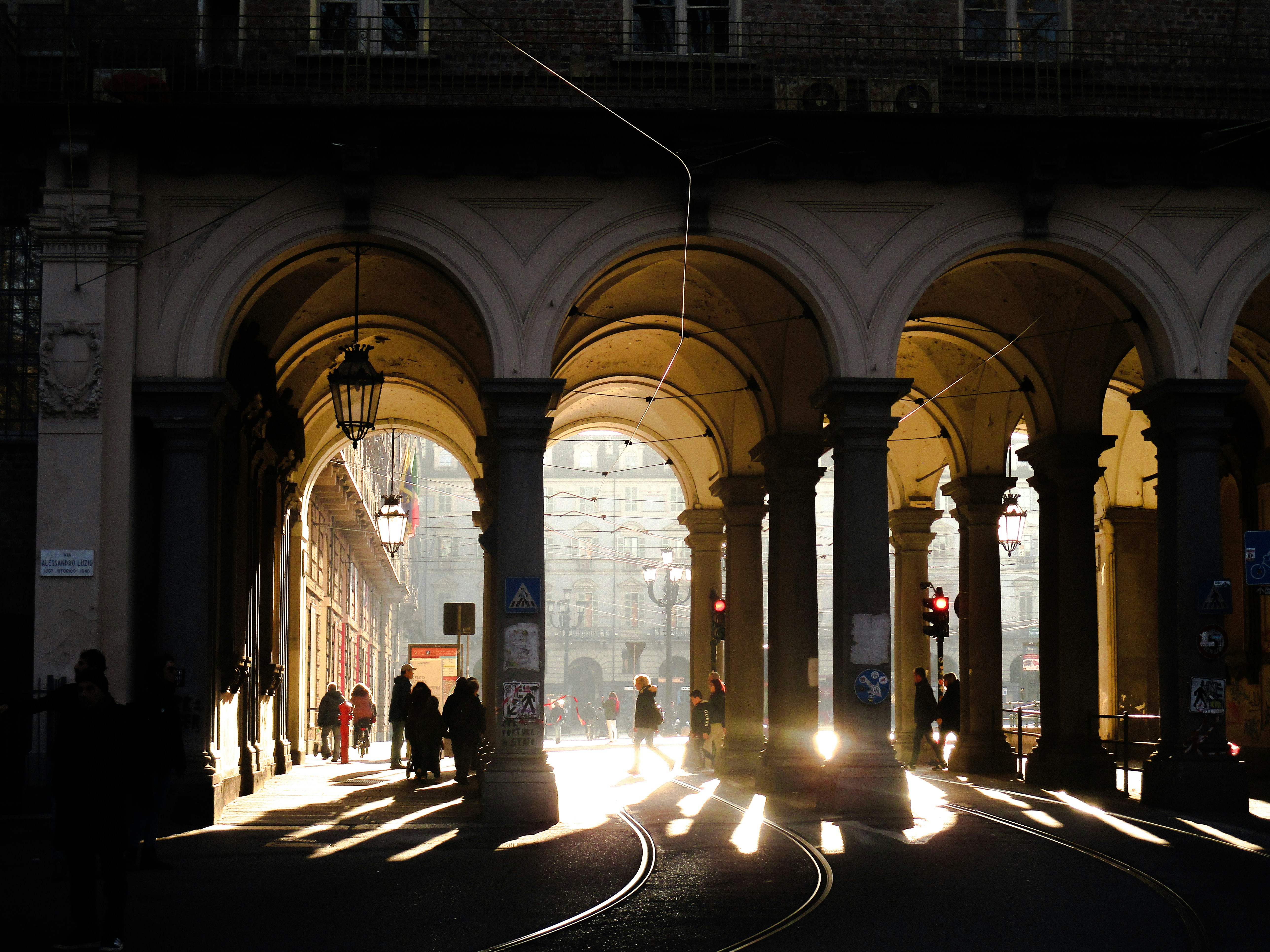 Sunlit Arches and tram Tracks: A City Corridor