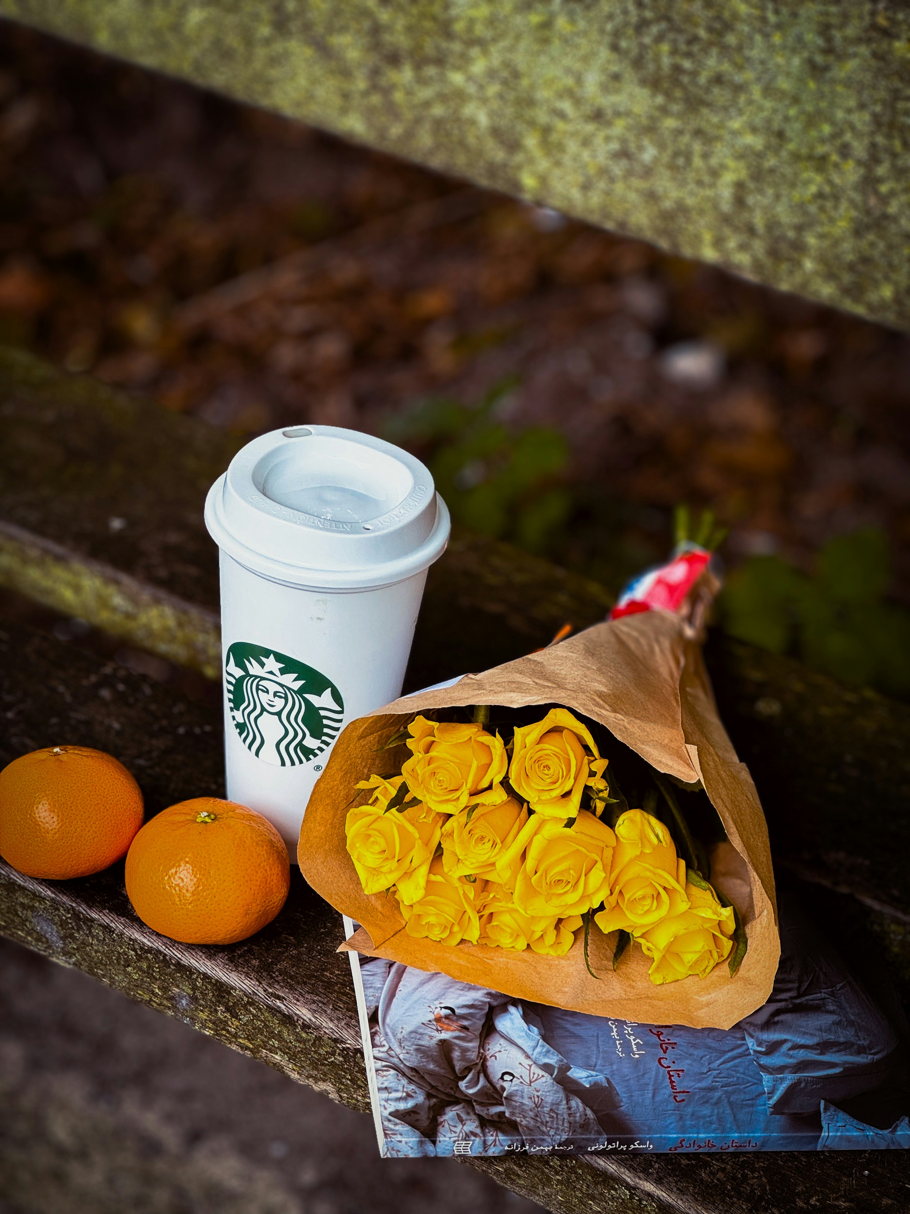 Benchside Citrine: A Starbucks Cup and a Burst of Yellow Roses