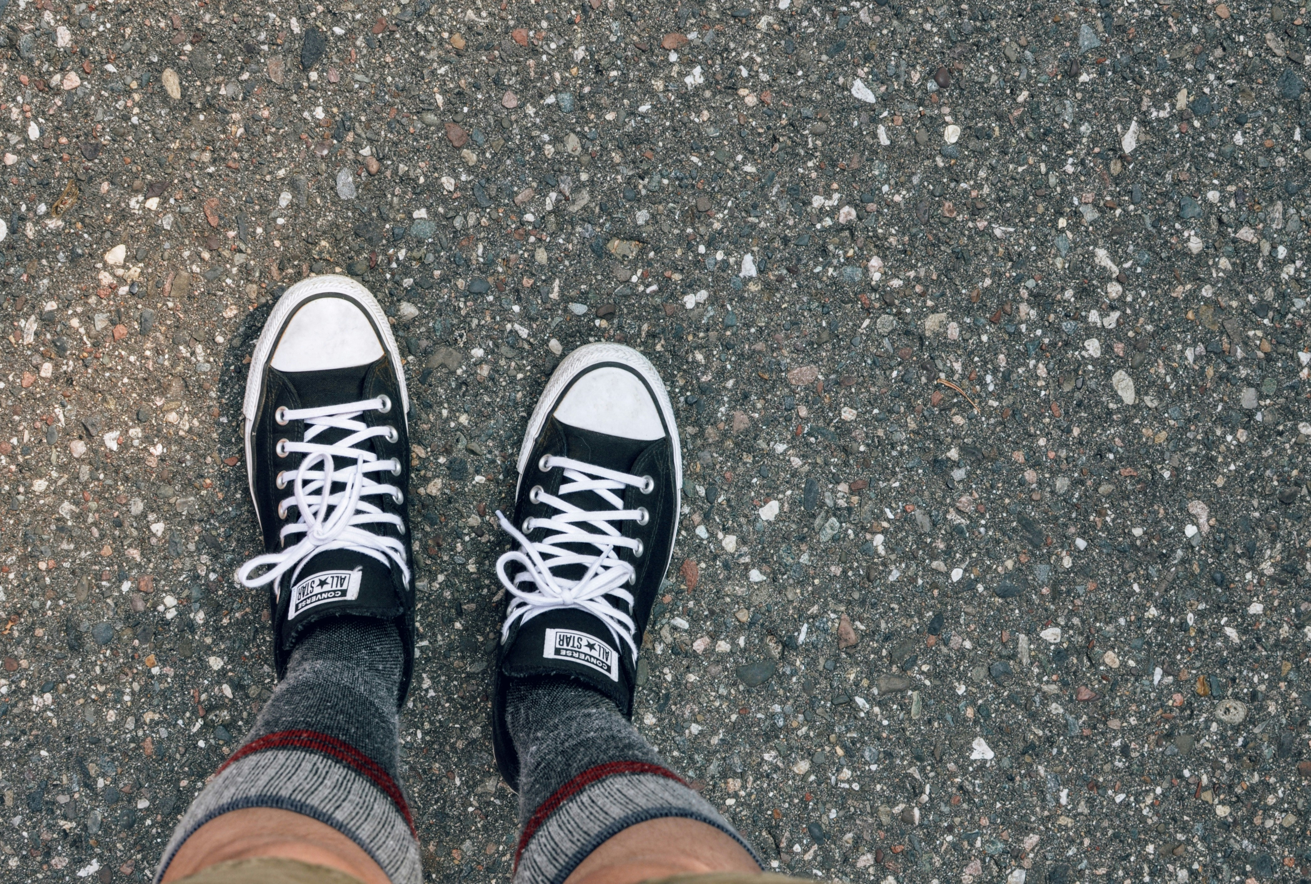 A person wearing black and white converse shoes photo – Free Feet Image ...