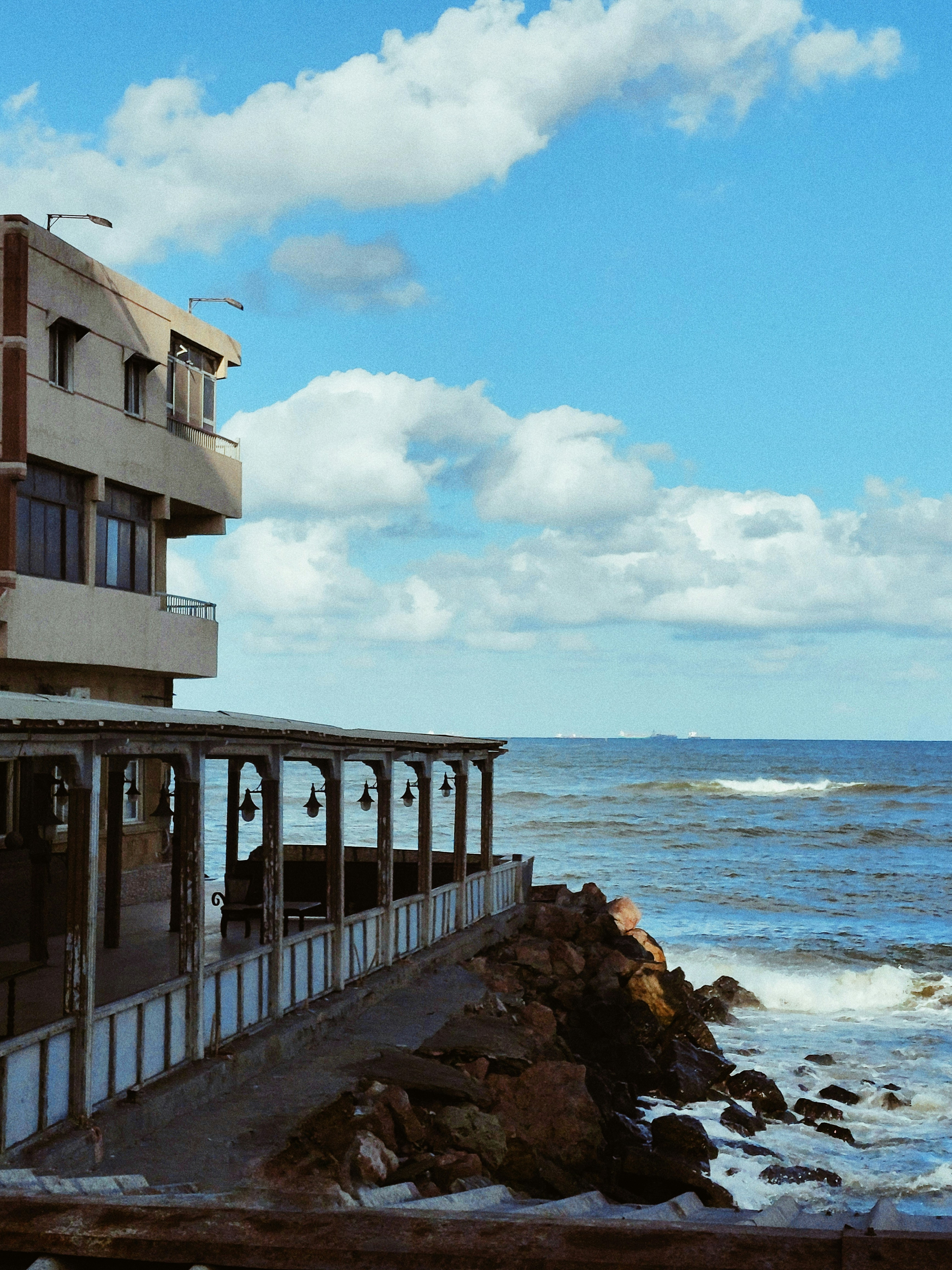 Coastal Veranda: Deck Columns Framing a Rugged Seascape