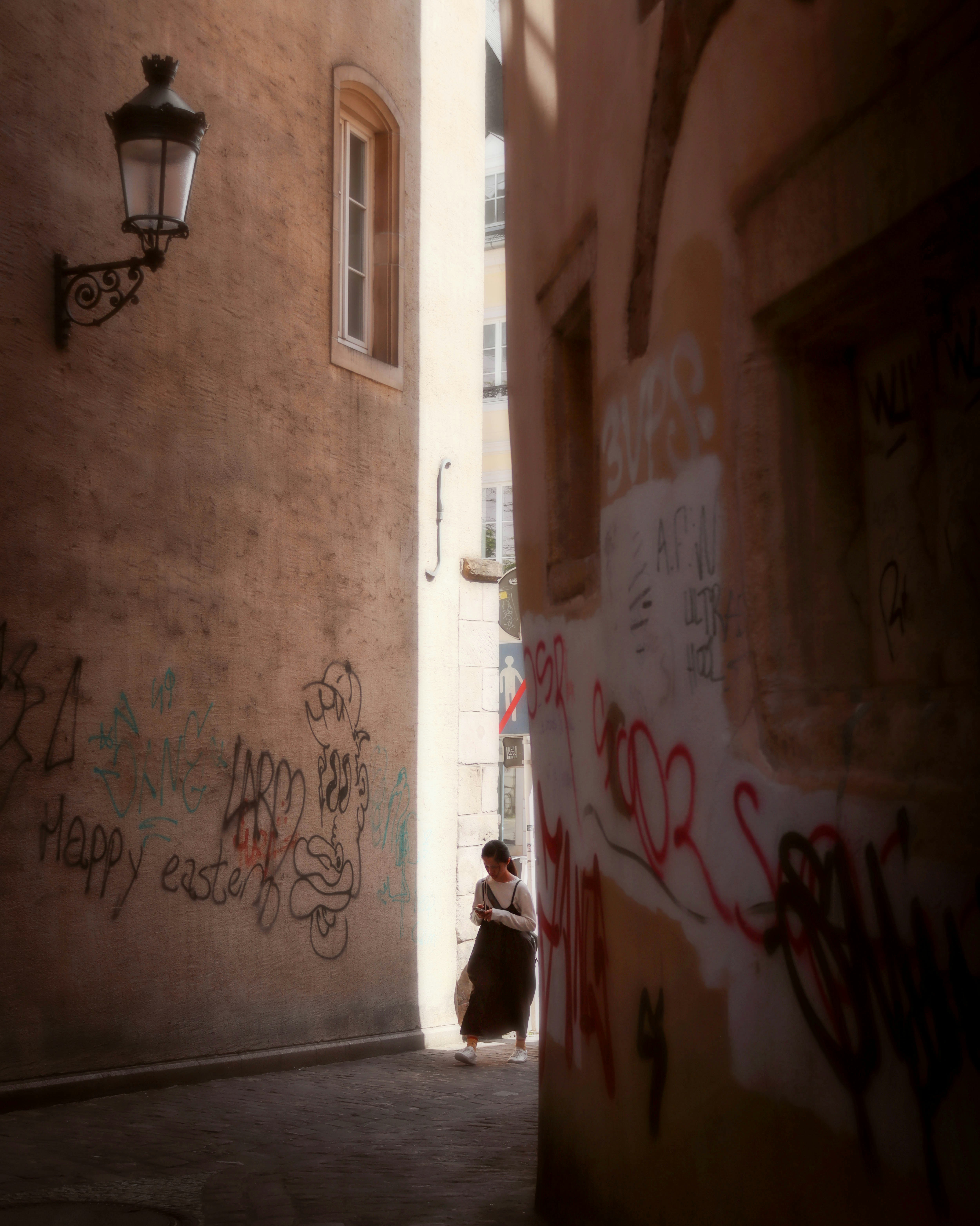 Solitary Step Through a Graffiti-Glow Alley
