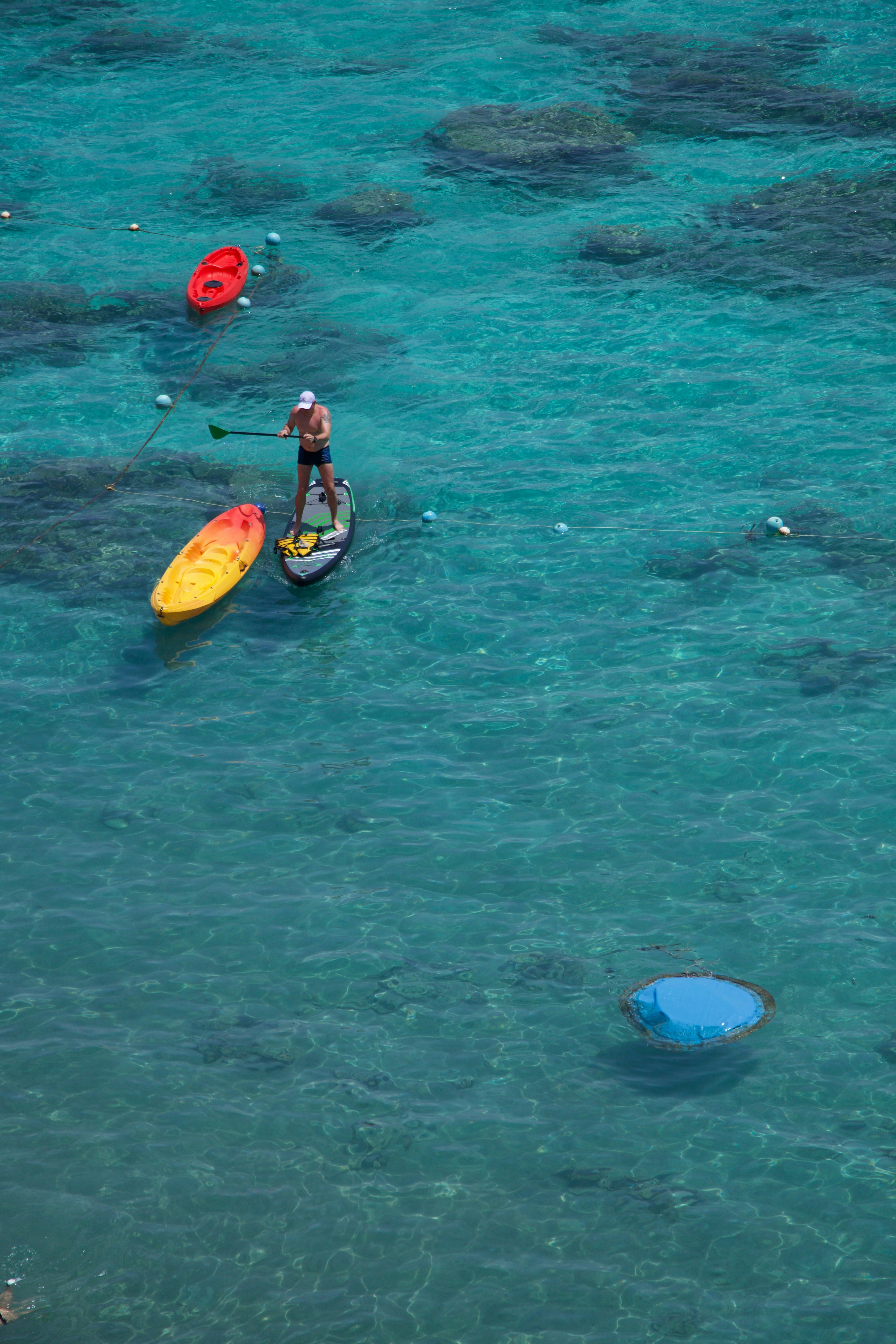 A man riding a surfboard on top of a body of water photo – Free Human ...