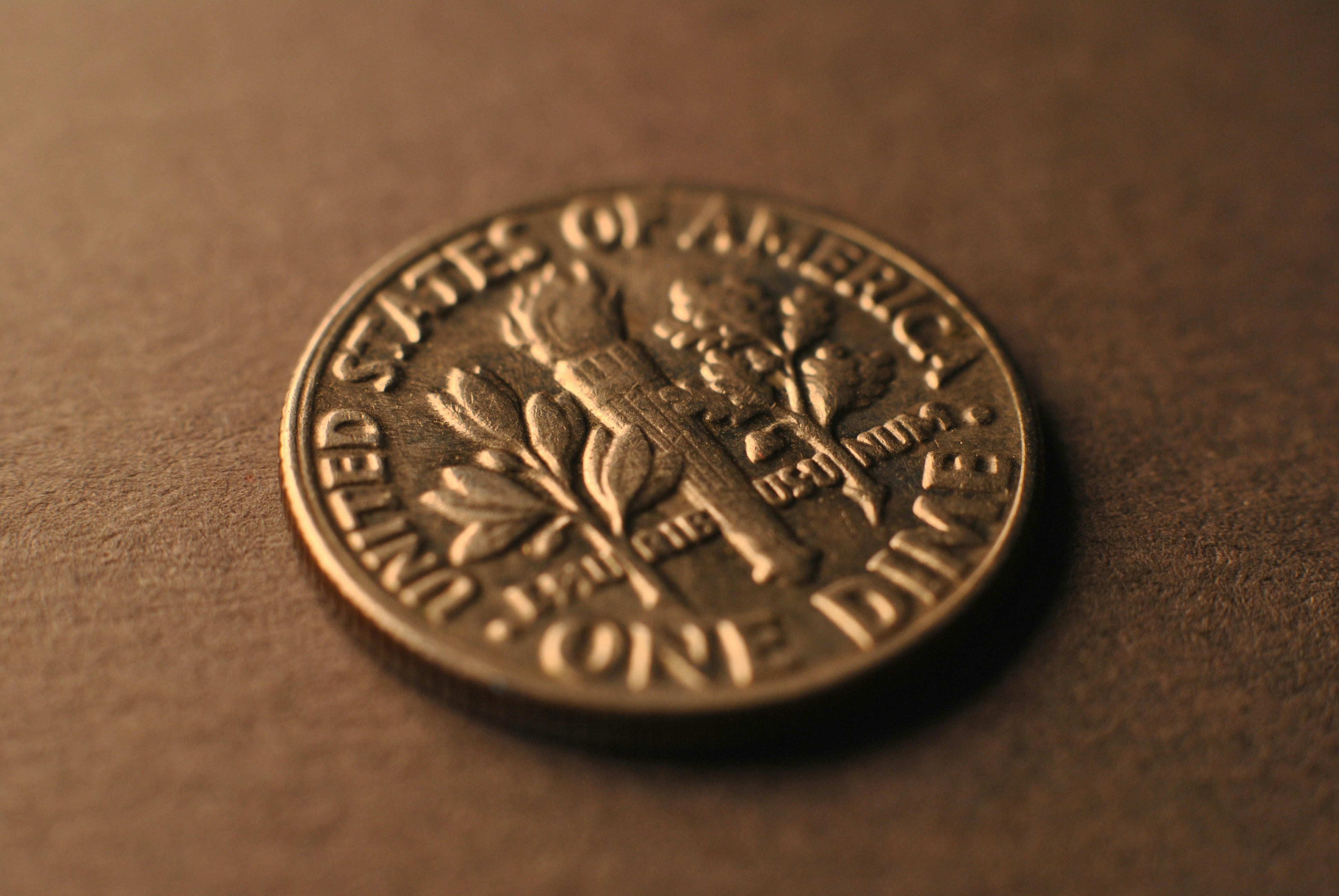 Macro Dime: Micro-relief and Warm Bokeh on a Lone Coin