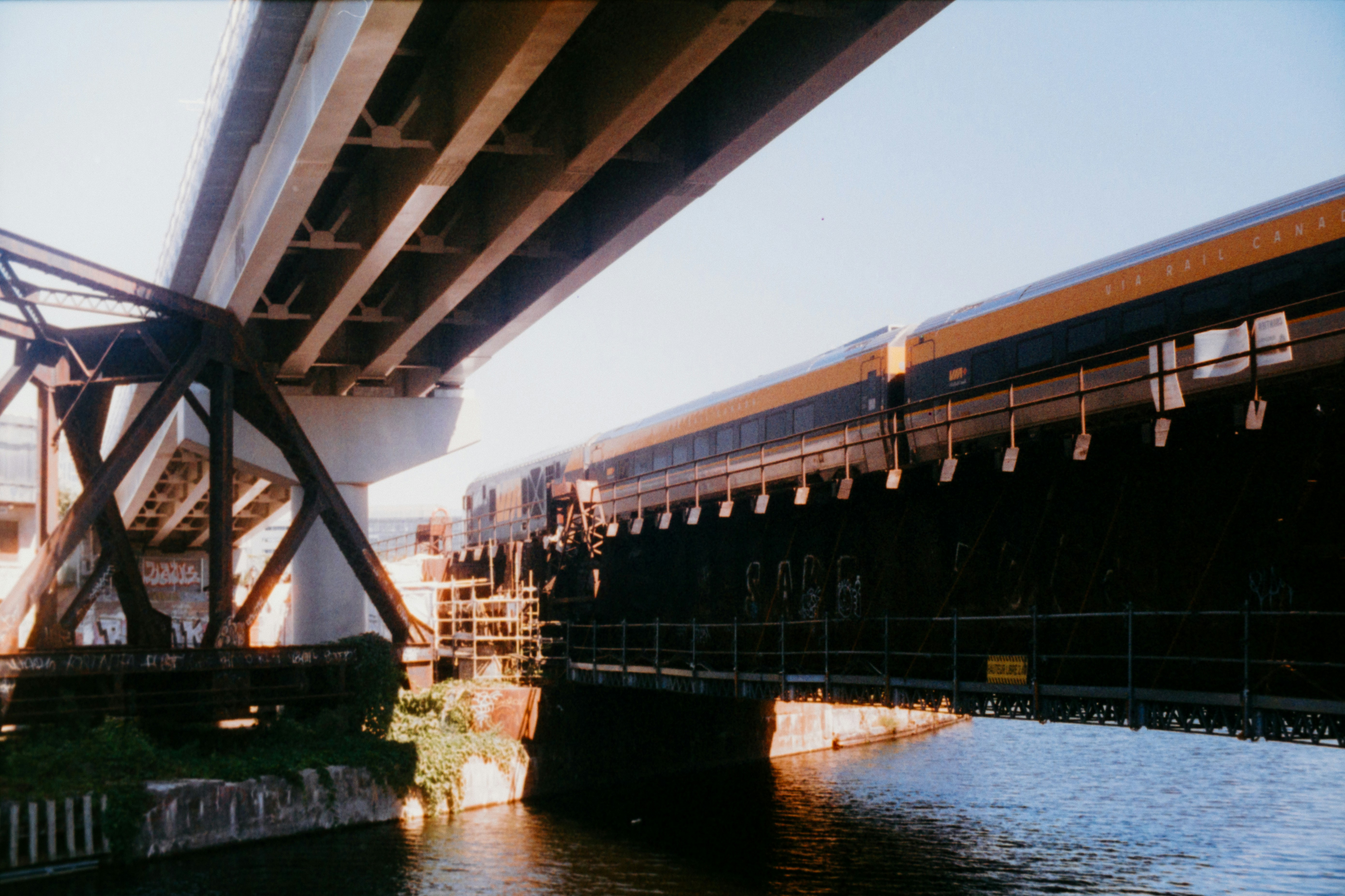A train traveling over a bridge over a river photo – Free Summer Image ...