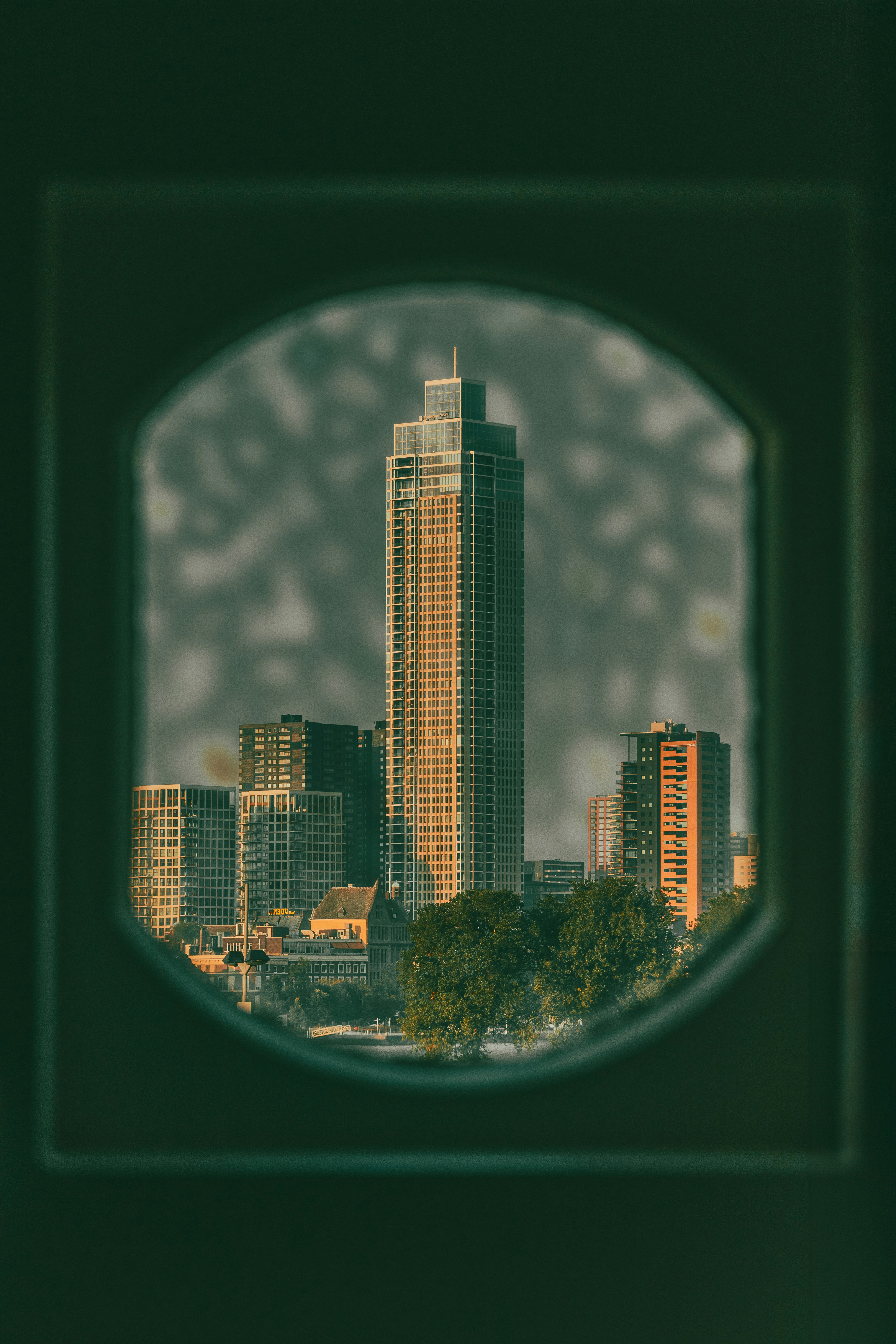 A view of a city through a circular window photo – Free Netherlands ...