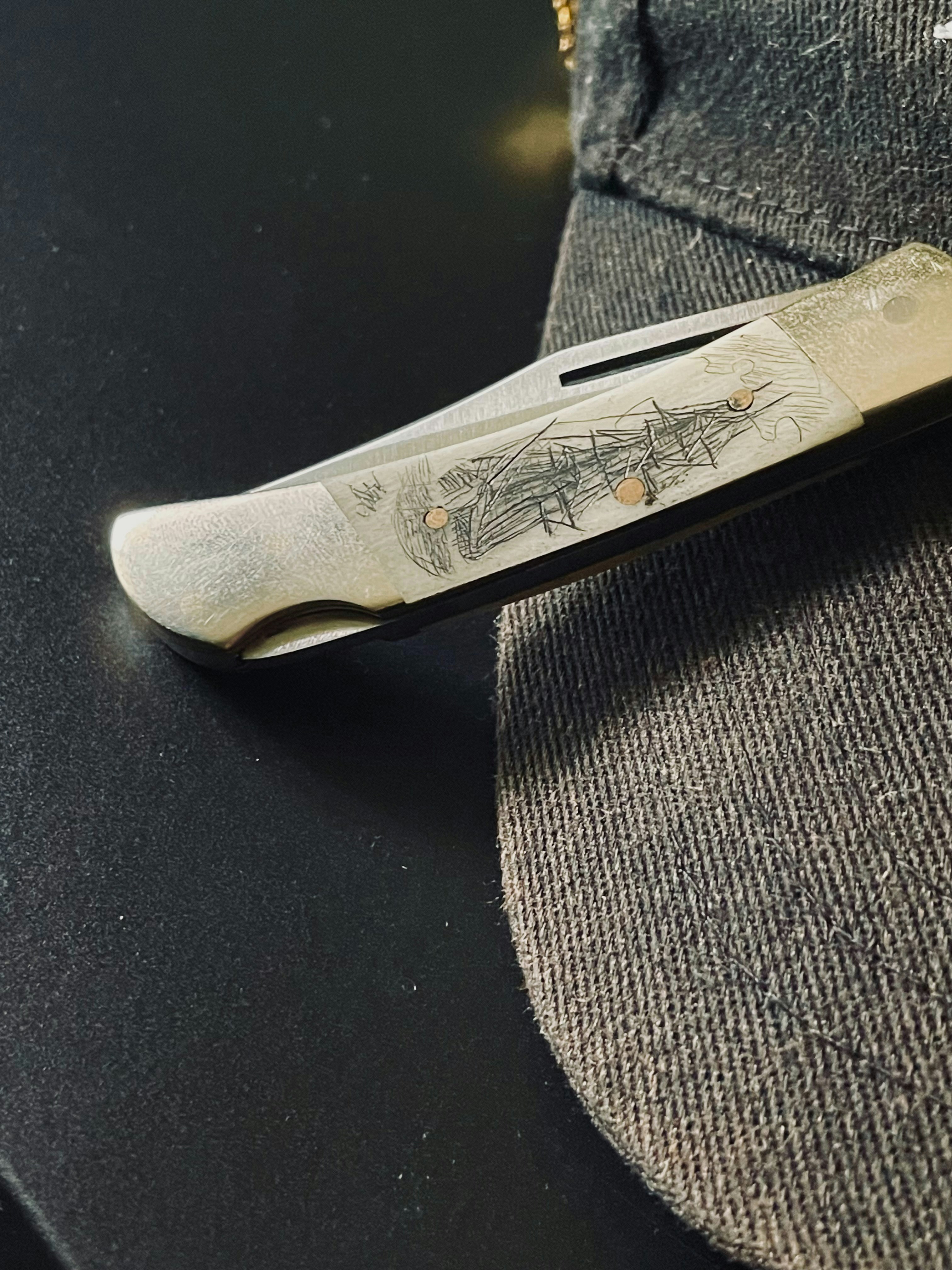 Slice of Craft: Engraved Pocket Knife on a Shadowed Fabric