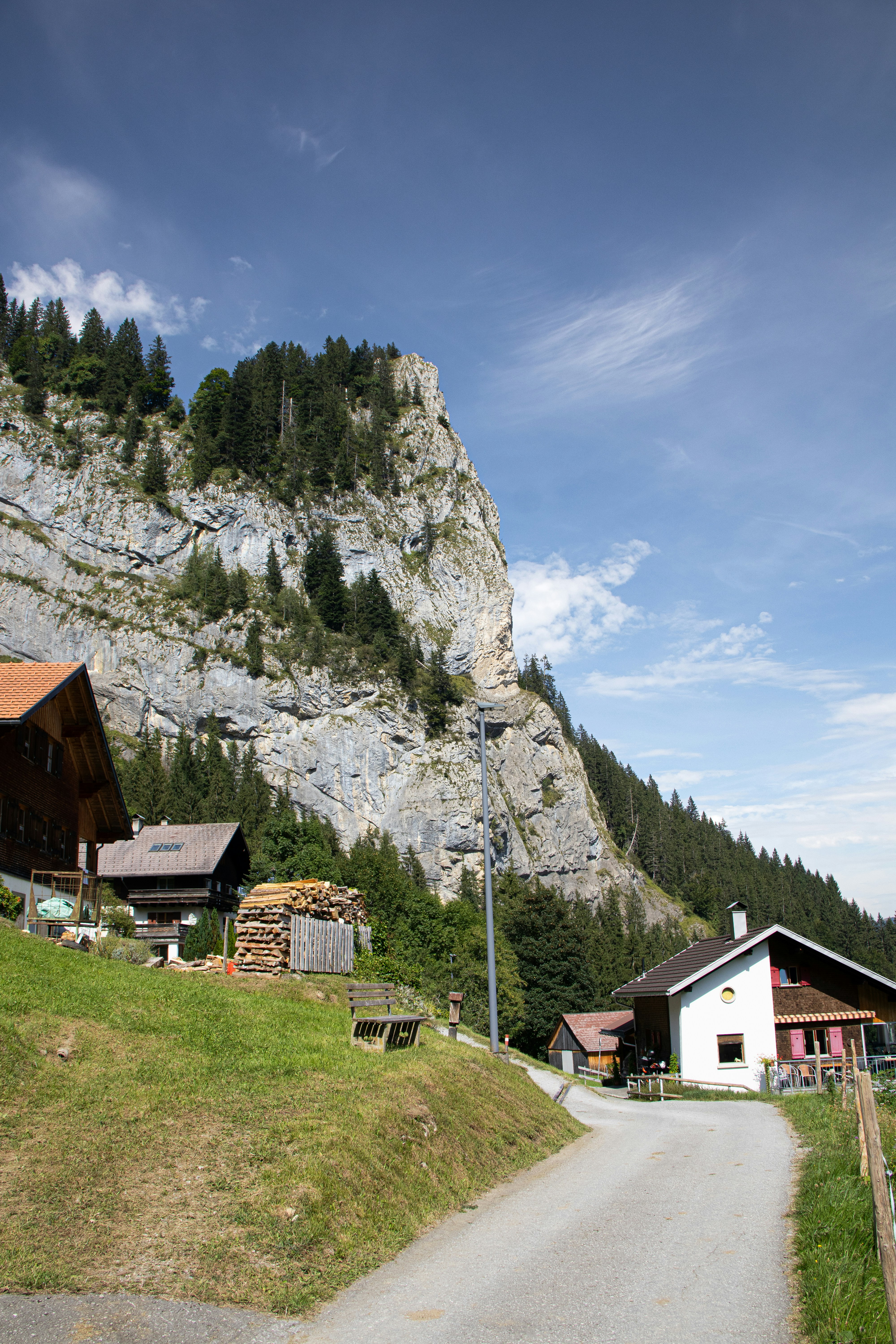 Cliffbound Alpine Village Along a Winding Mountain Road