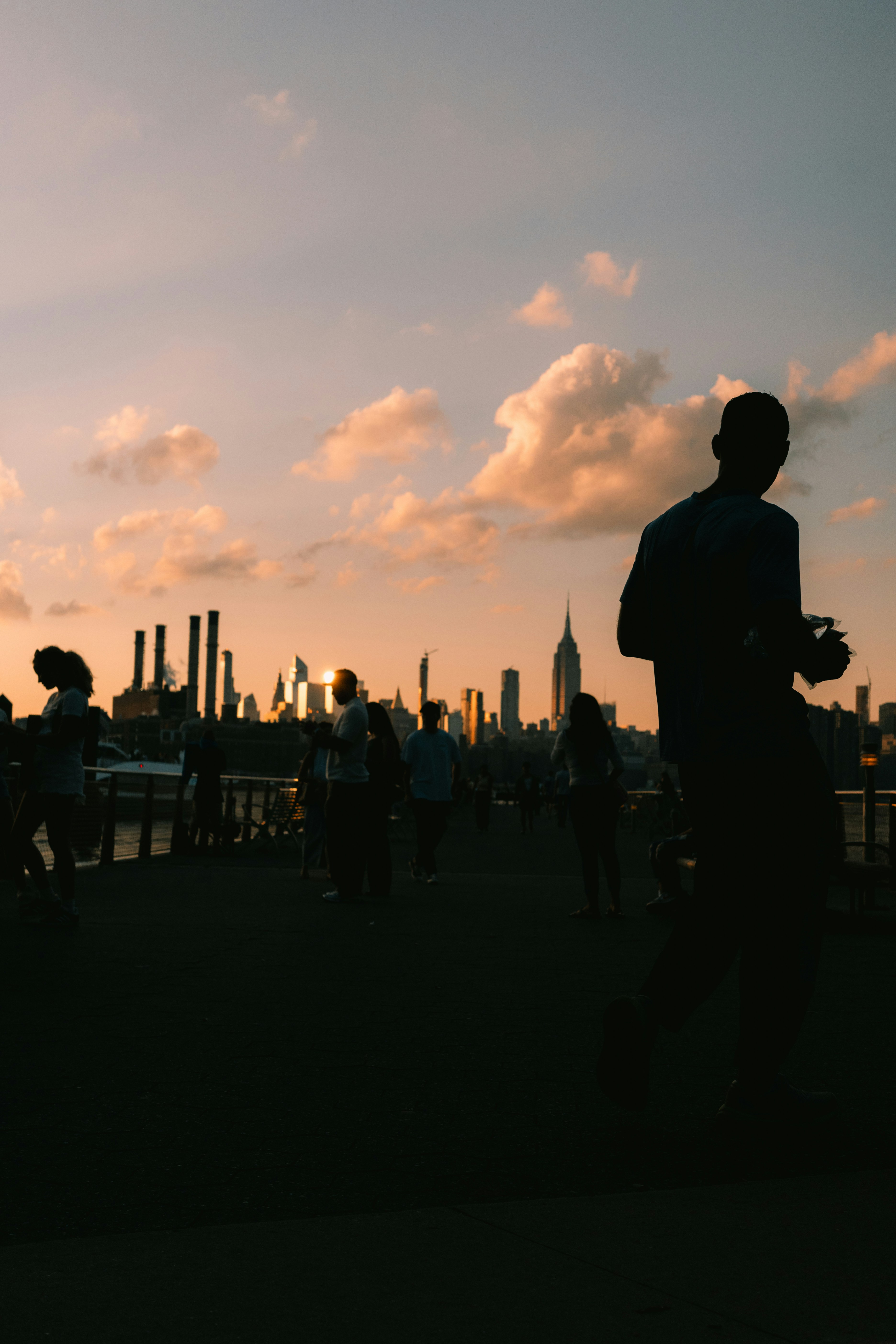 Last Light Over NYC Promenade: A Silhouette Against the Peach Sky