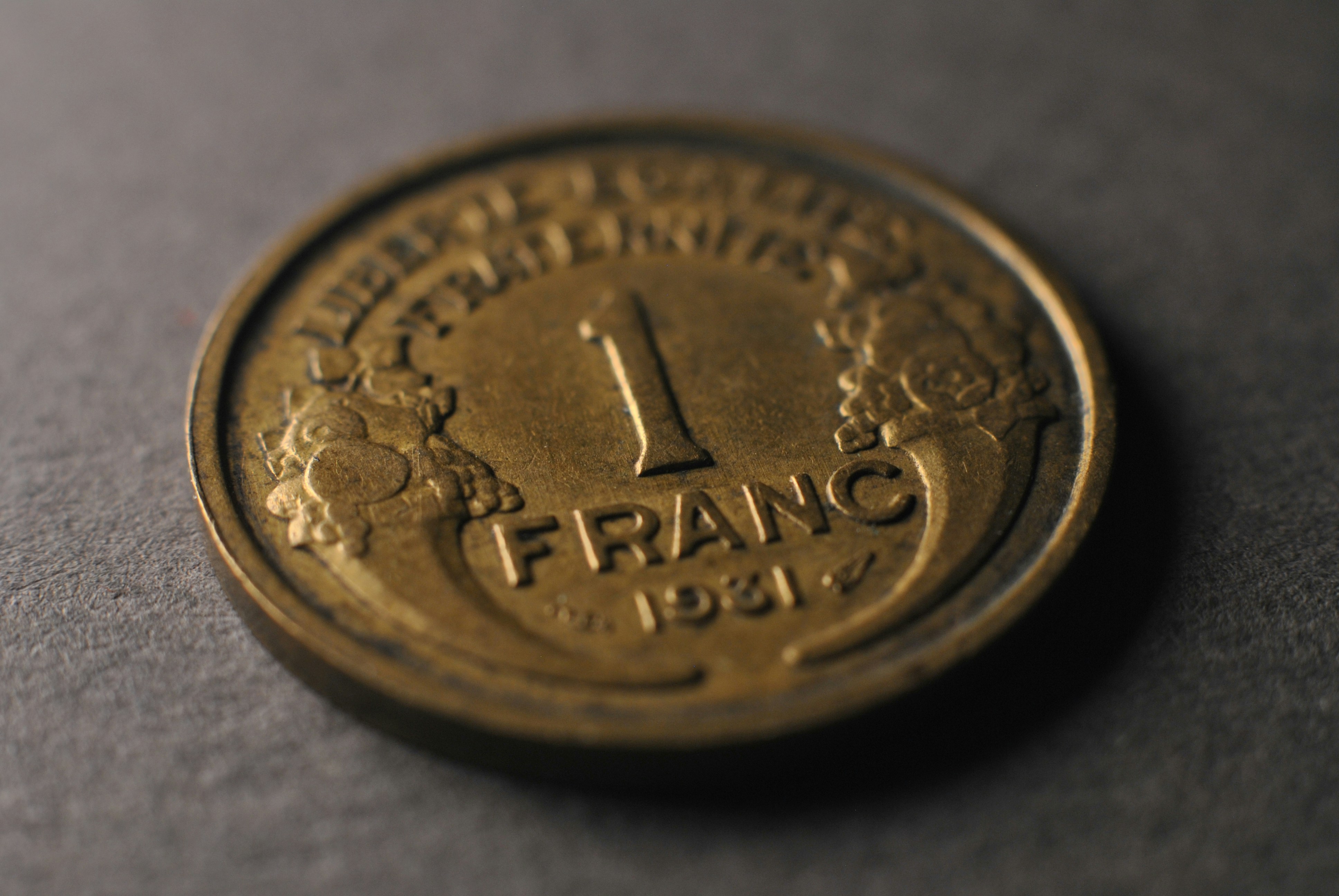 Macro Portrait of a 1 Franc Coin on a Textured Gray Surface